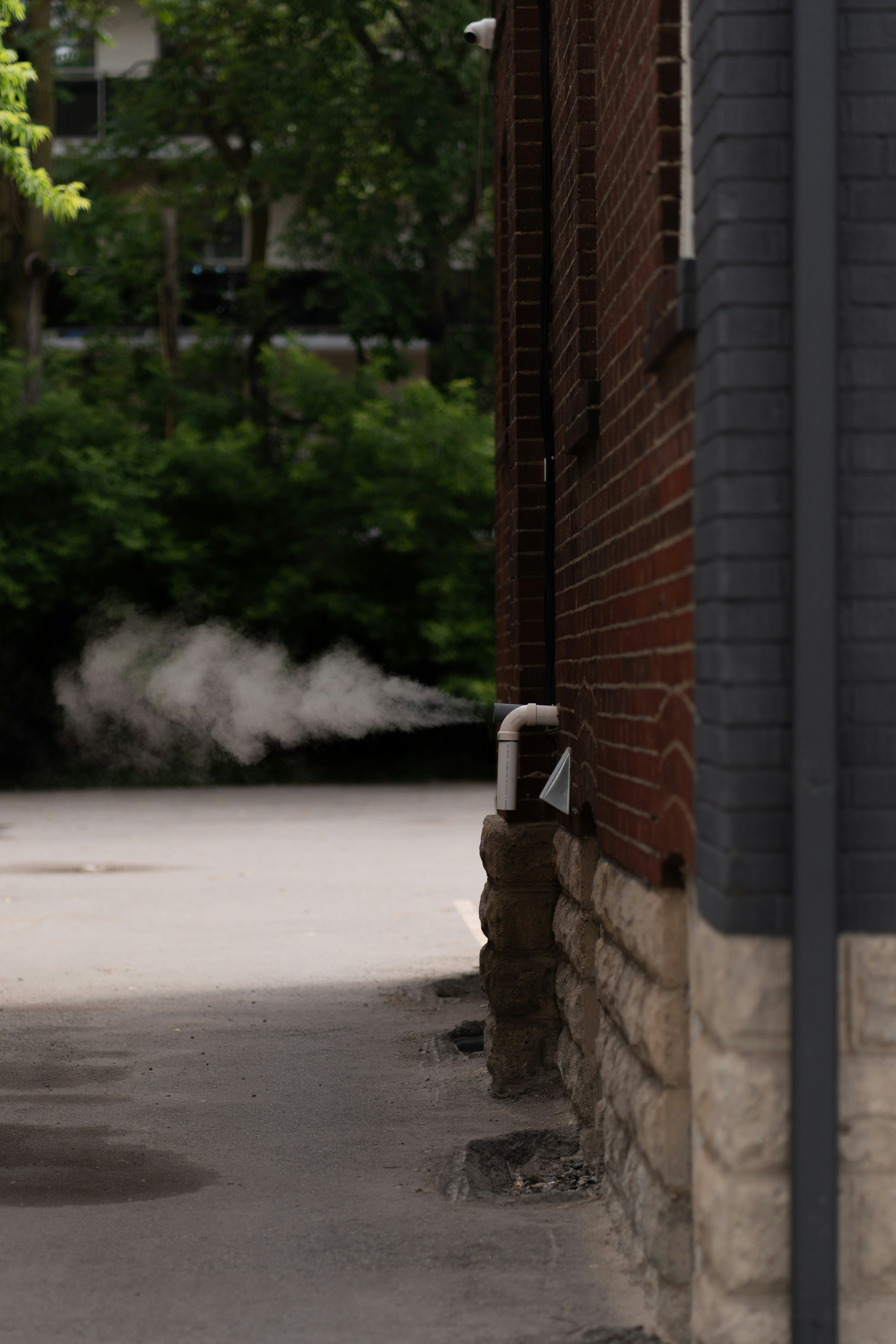 Alley Vent: Steam Trails from a Brick Facade