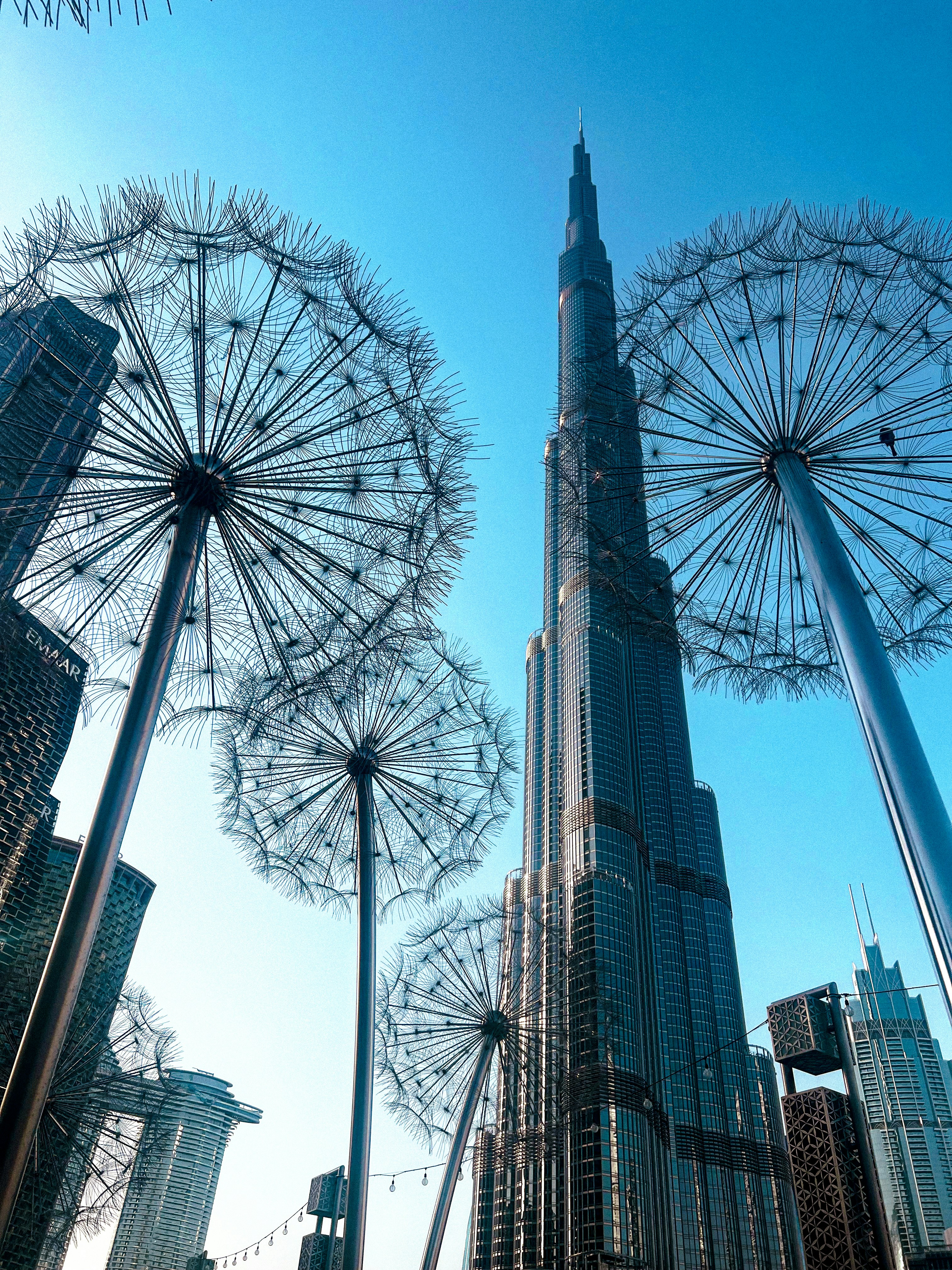 Burj Khalifa Framed by Skyward Dandelion Arches Under a Cerulean Dubai Sky