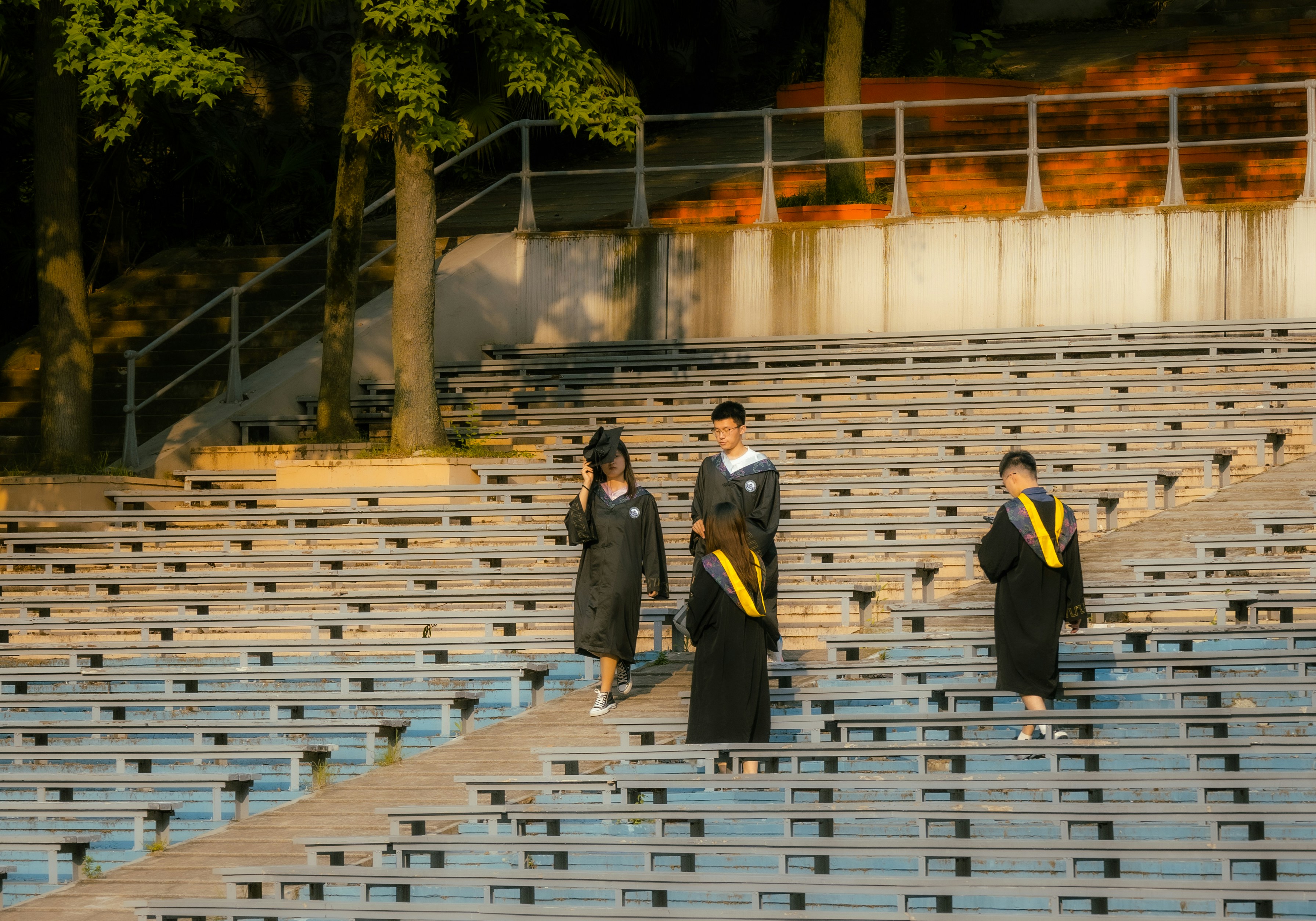 A group of people standing on top of a bleachers photo – Free Portrait ...