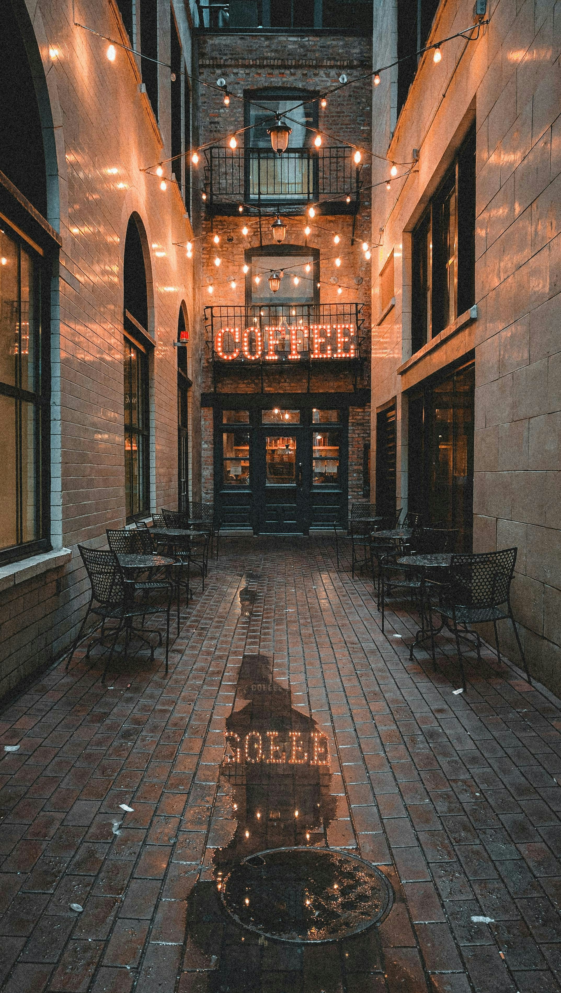An empty street with tables and chairs in it photo – Free Building ...