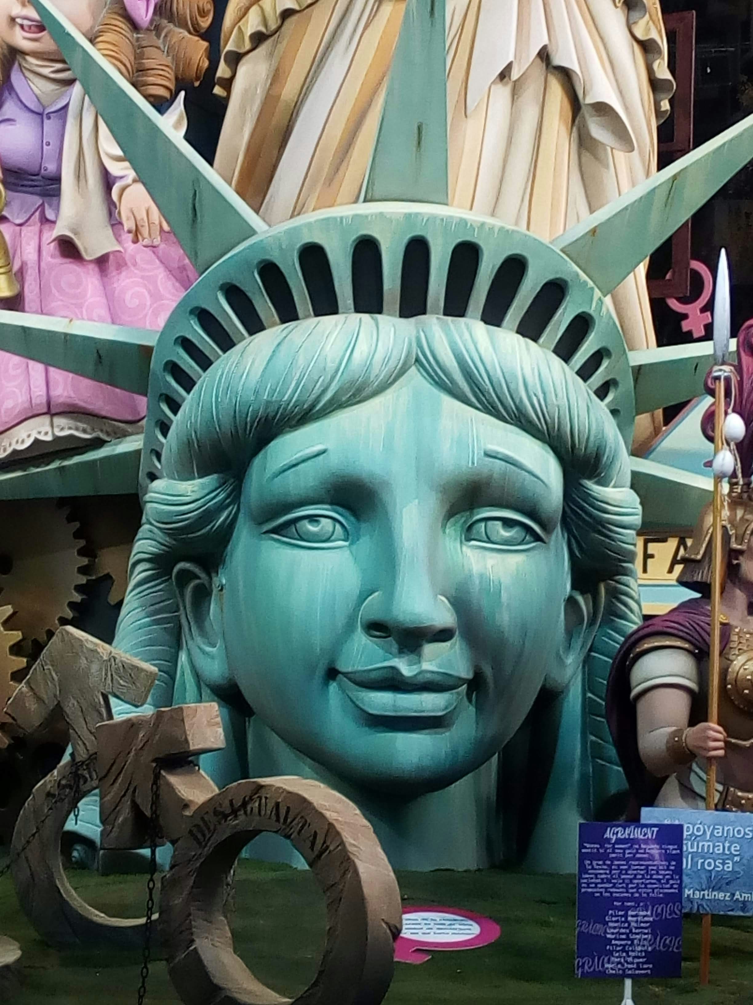 The statue of liberty is surrounded by other statues photo – Free Woman ...