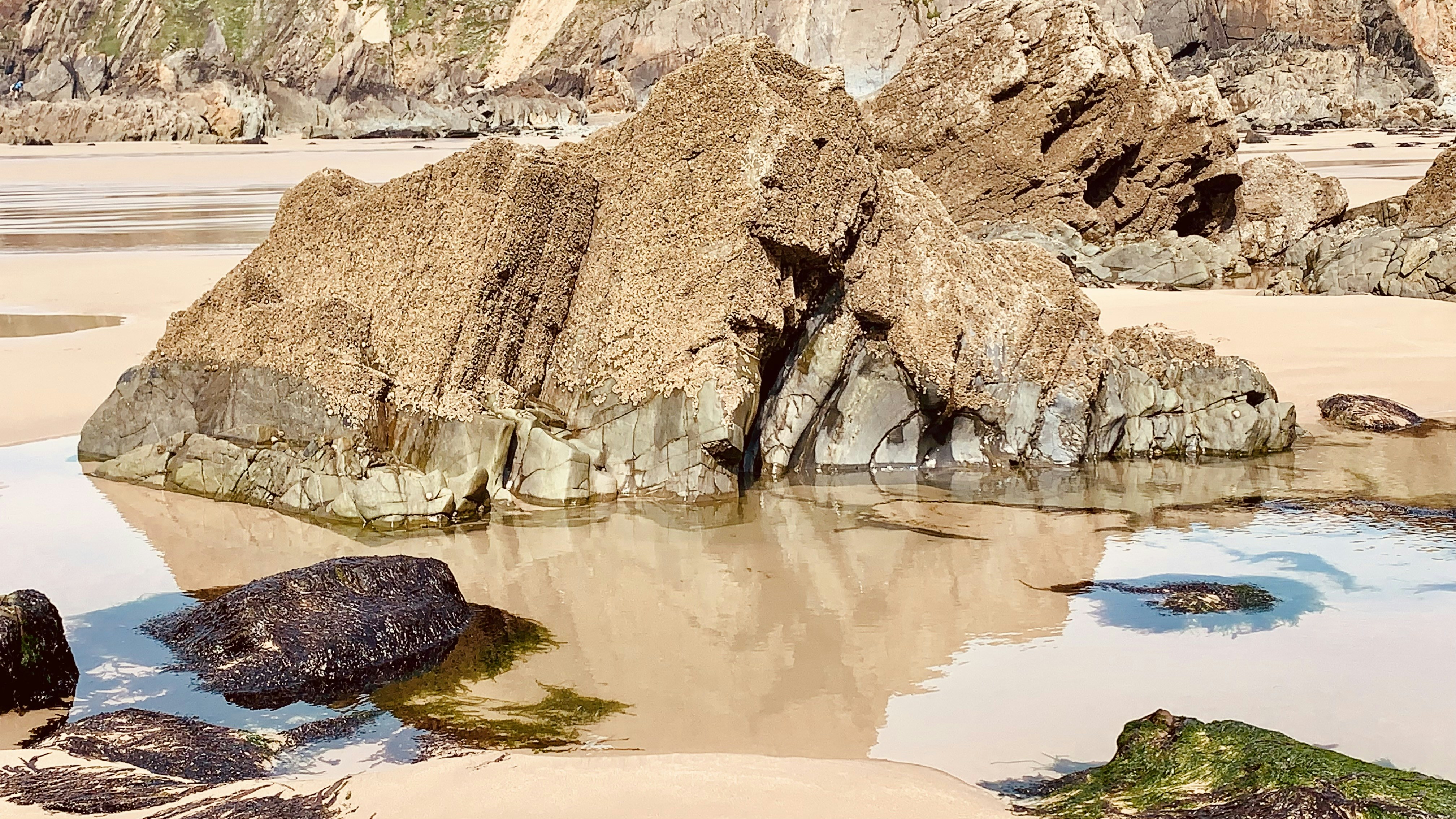 Marlowe Sands West Wales | A beach with rocks and a body of water