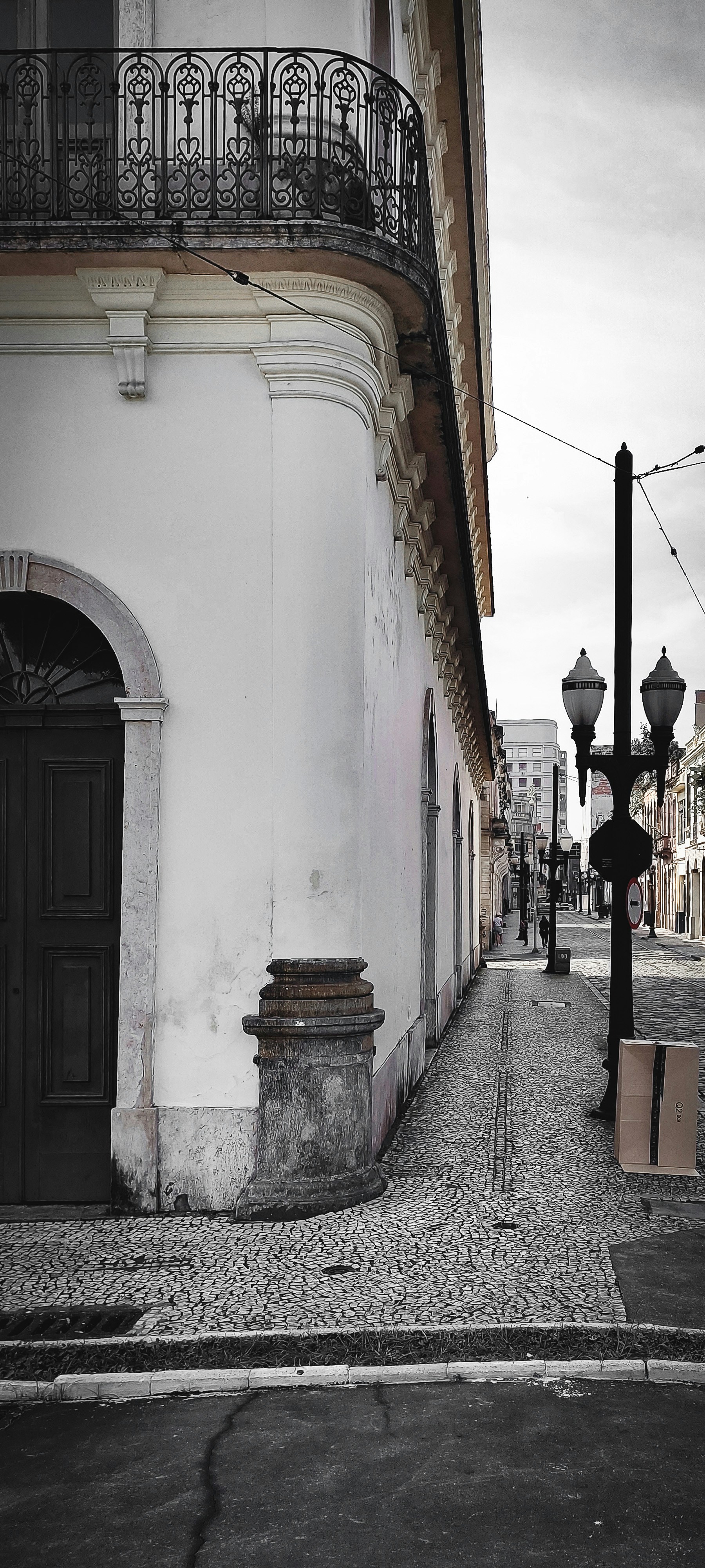 A black and white photo of a street corner