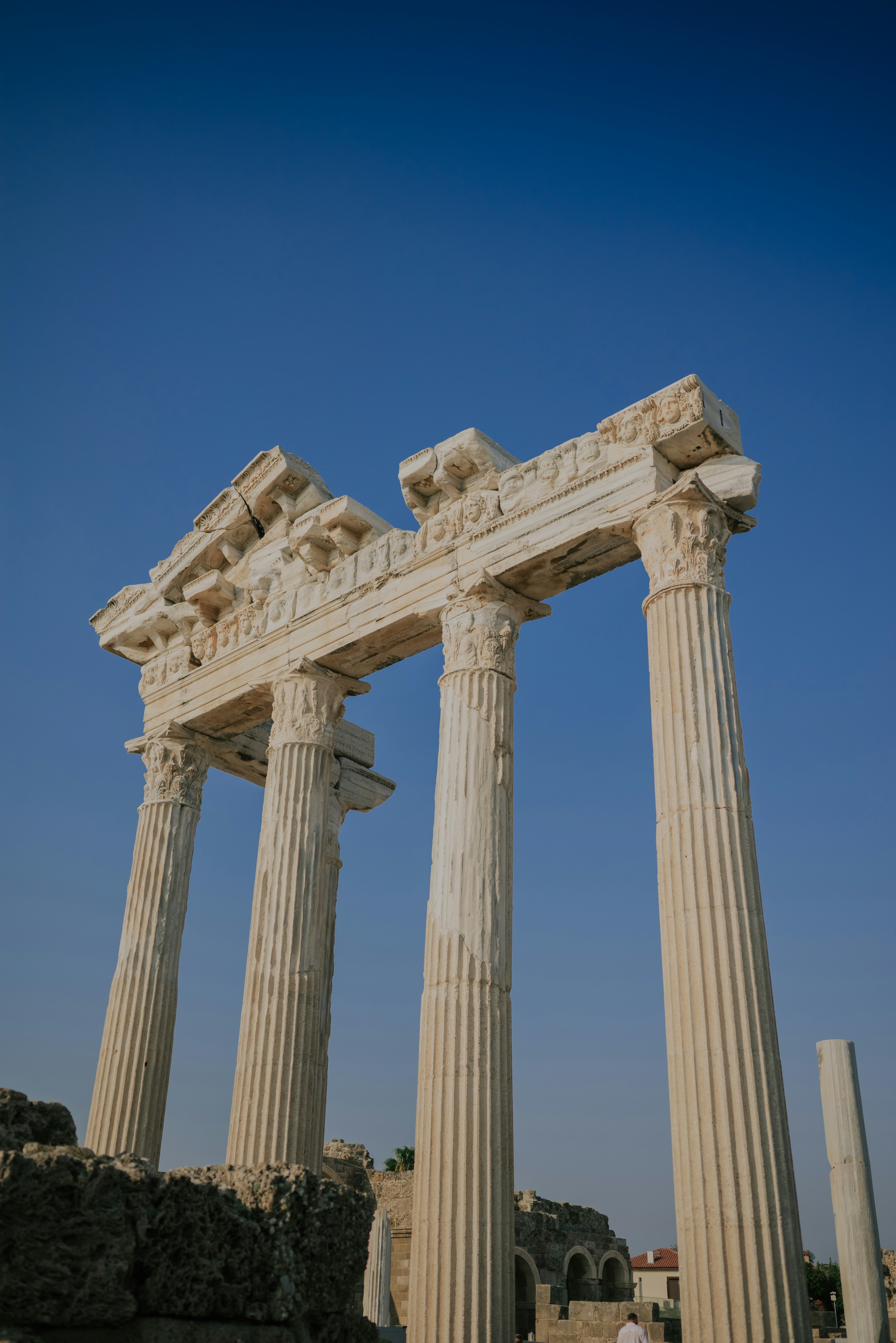 A man standing in front of some very tall pillars photo – Free Building ...