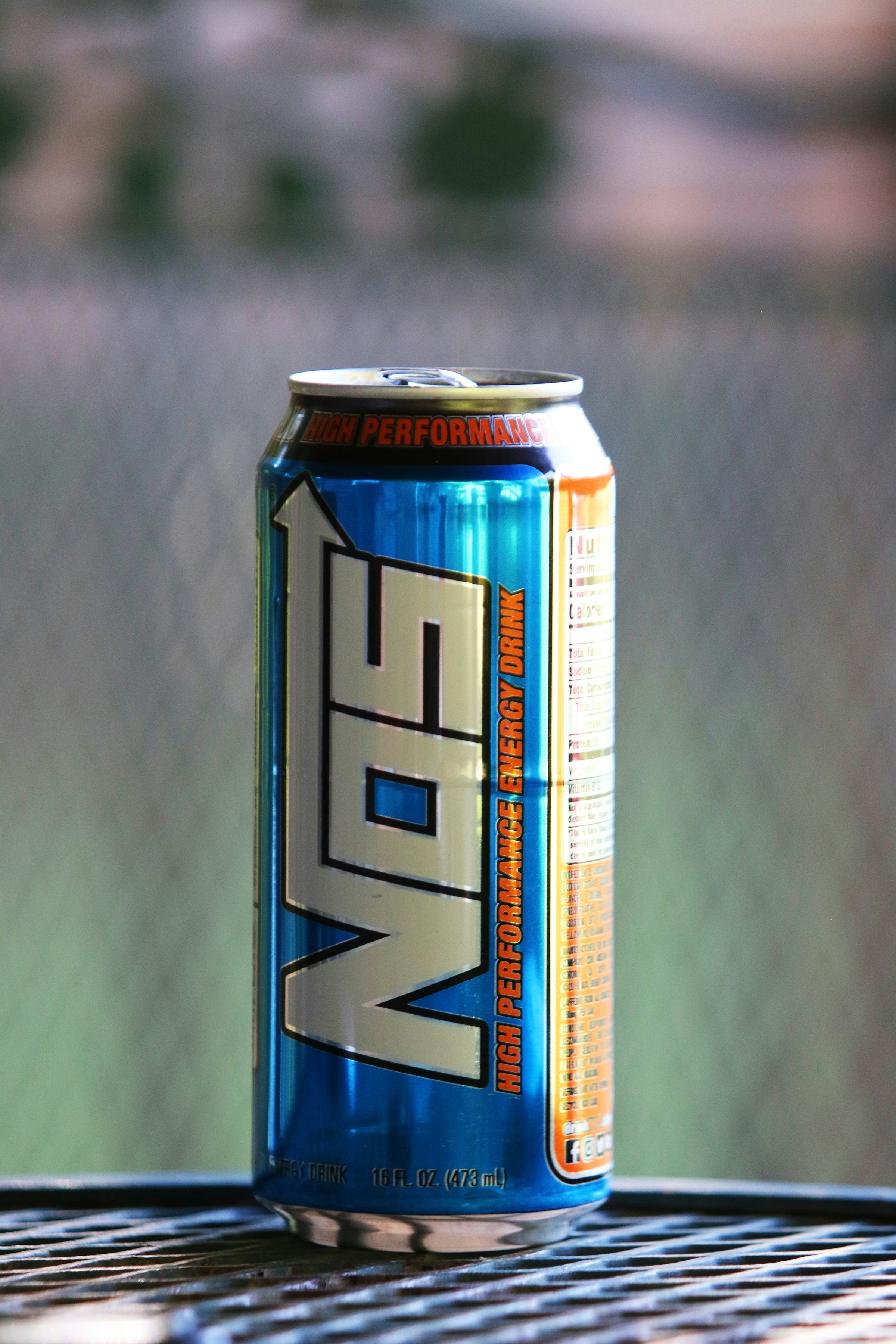 Blue Pulse on a Metal Grate: A lone energy can anchors the frame