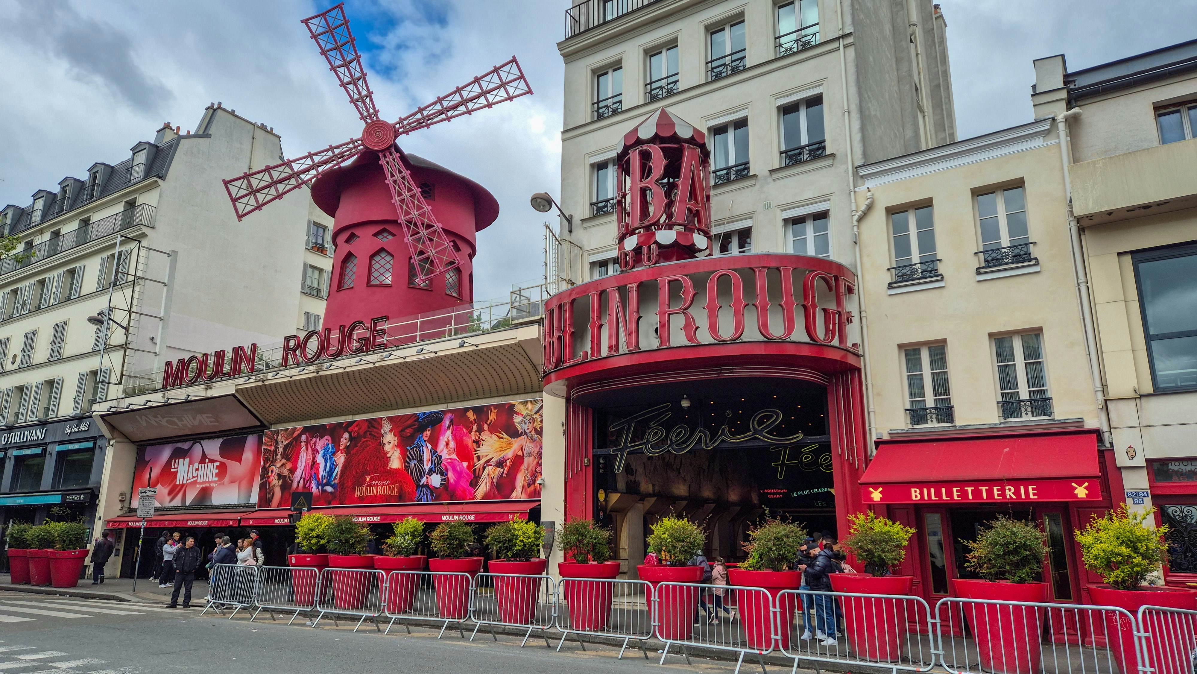 A red building with a windmill on top of it photo – Free Paris Image on ...