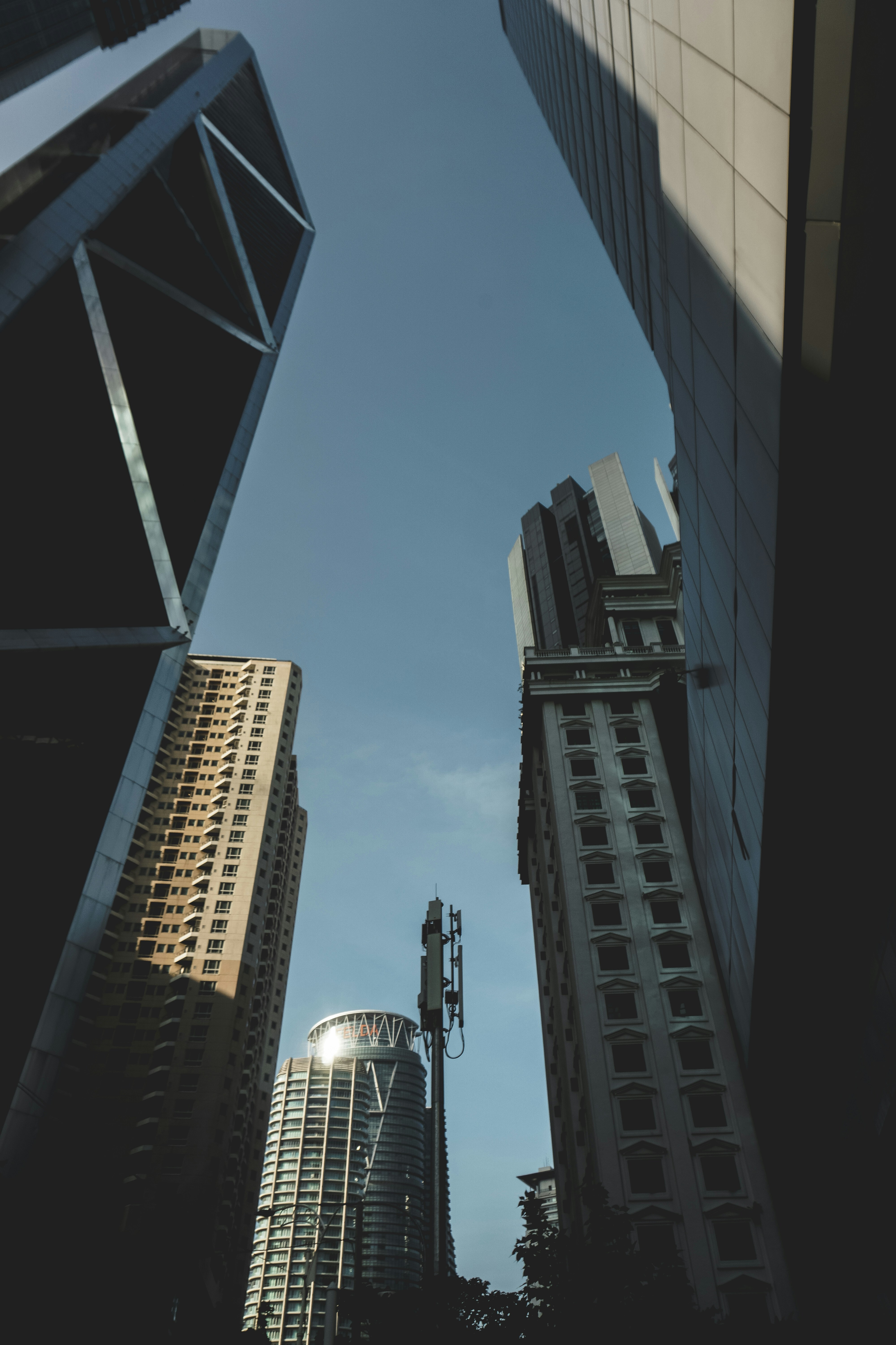 Looking up at tall buildings in a city photo – Free Klcc Image on Unsplash