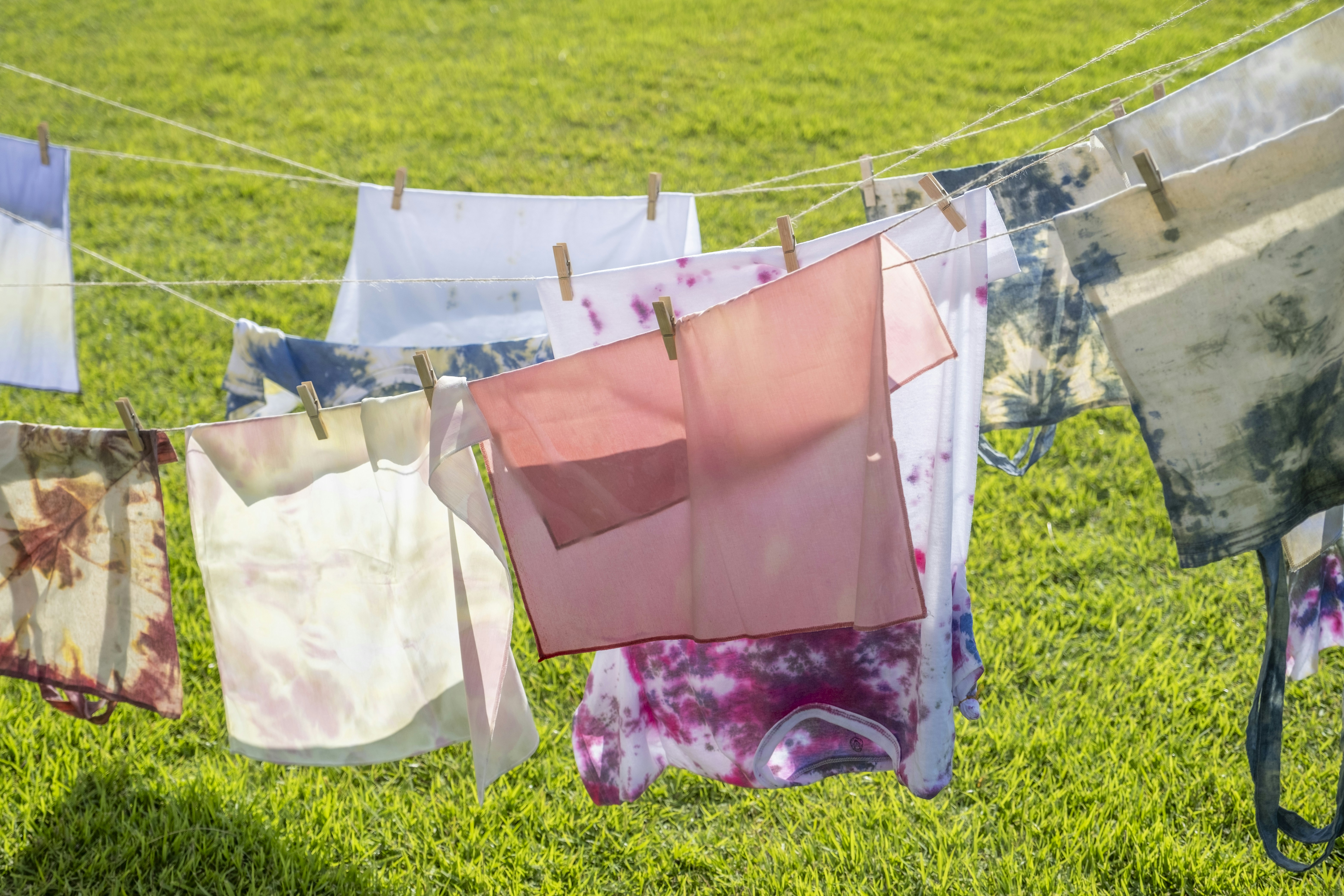 A line of clothes hanging on a clothes line photo – Free Cloth Image on ...