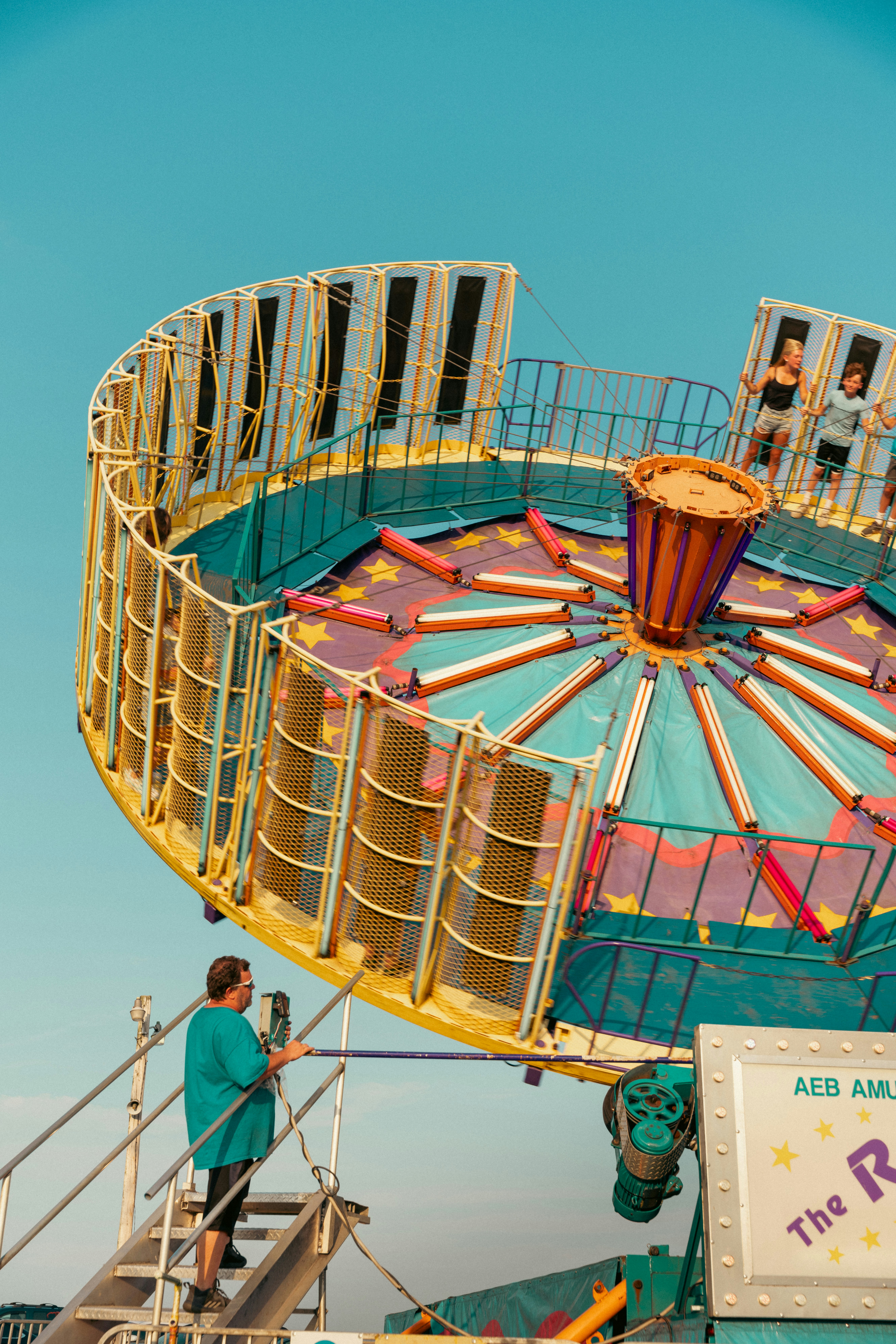 A carnival ride with people standing on it photo – Free People Image on ...