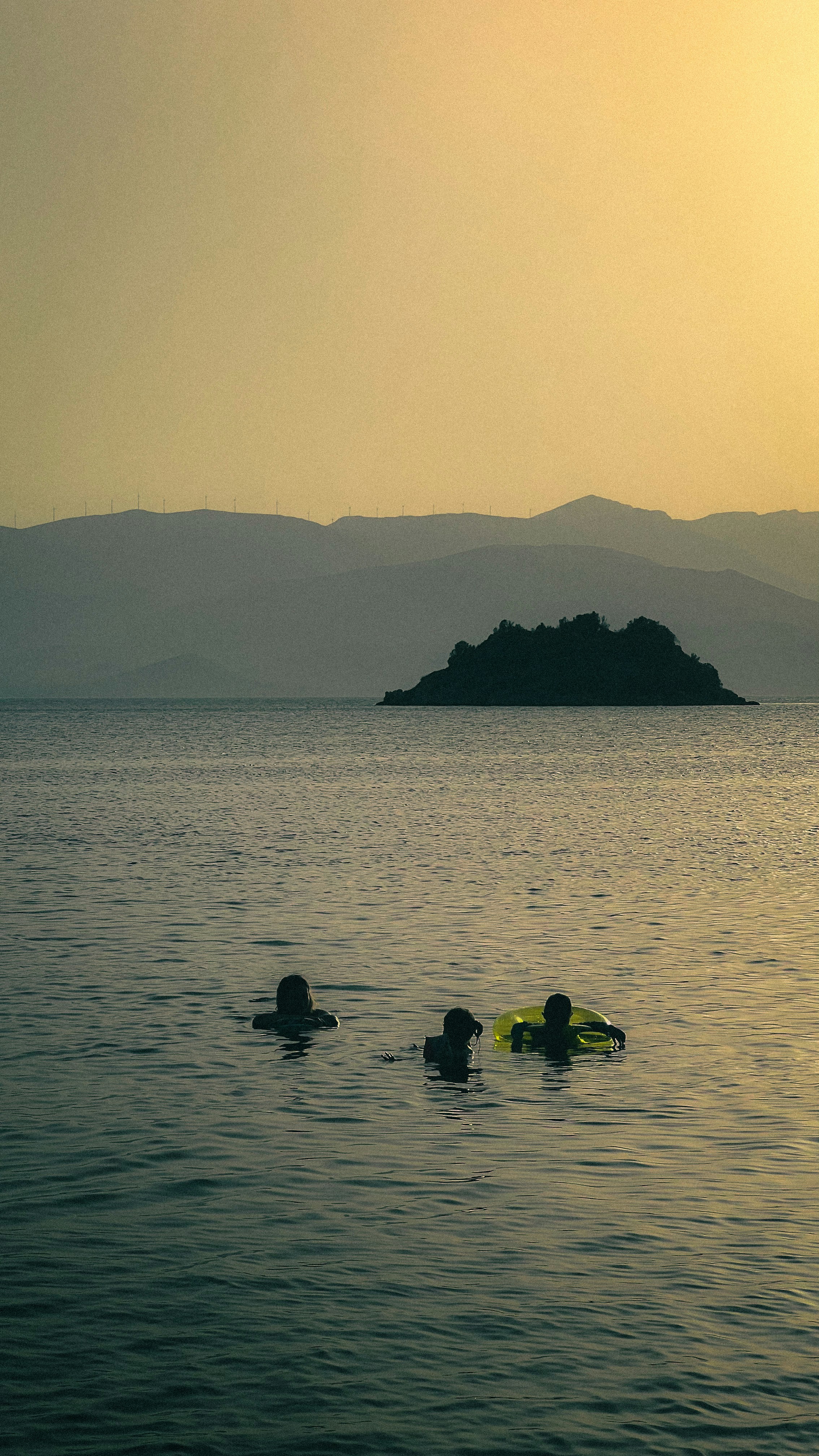 Dusk Silhouette over the Quiet Sea: Island on the Horizon