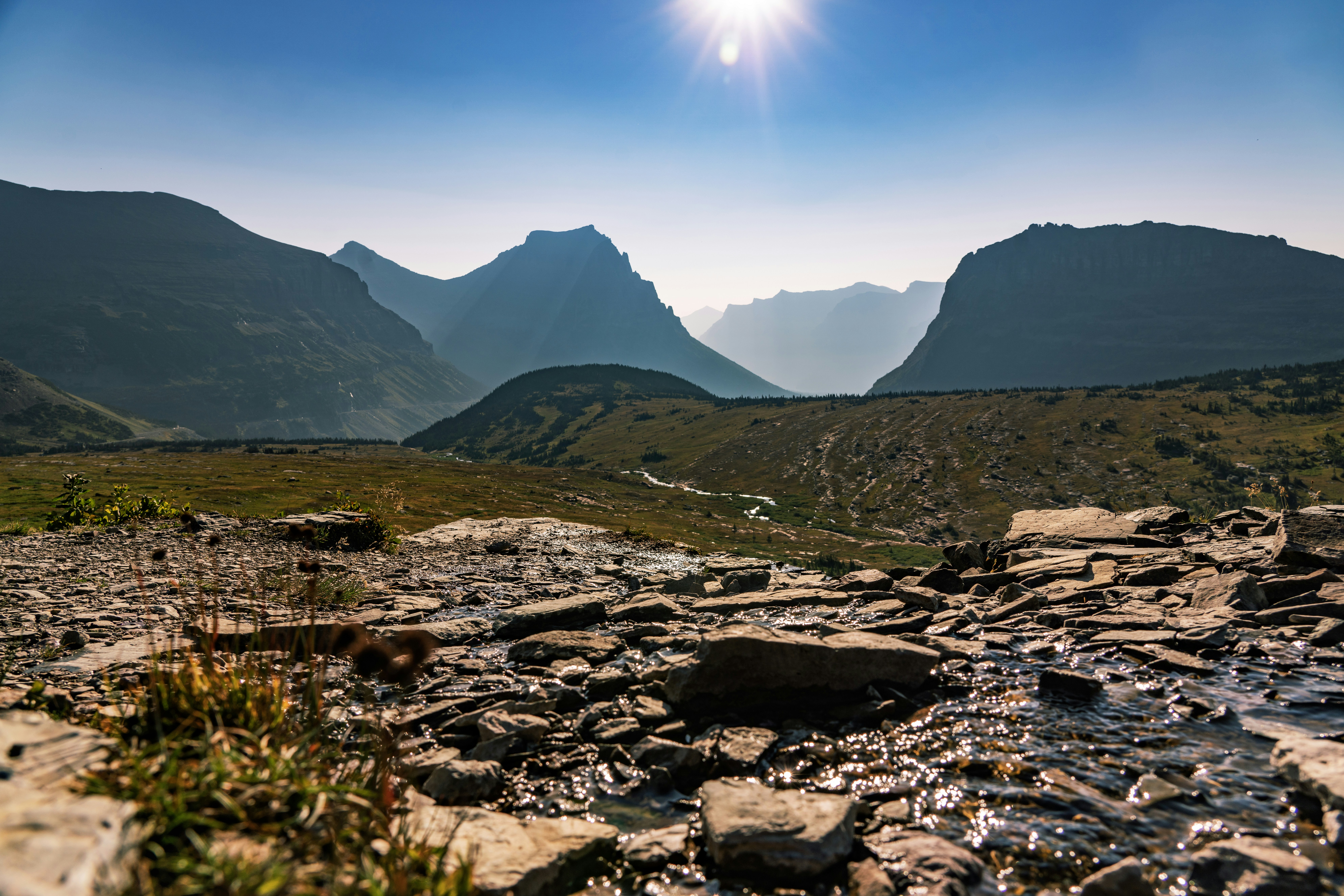 The sun is shining over the mountains and rocks photo – Free Glacier ...