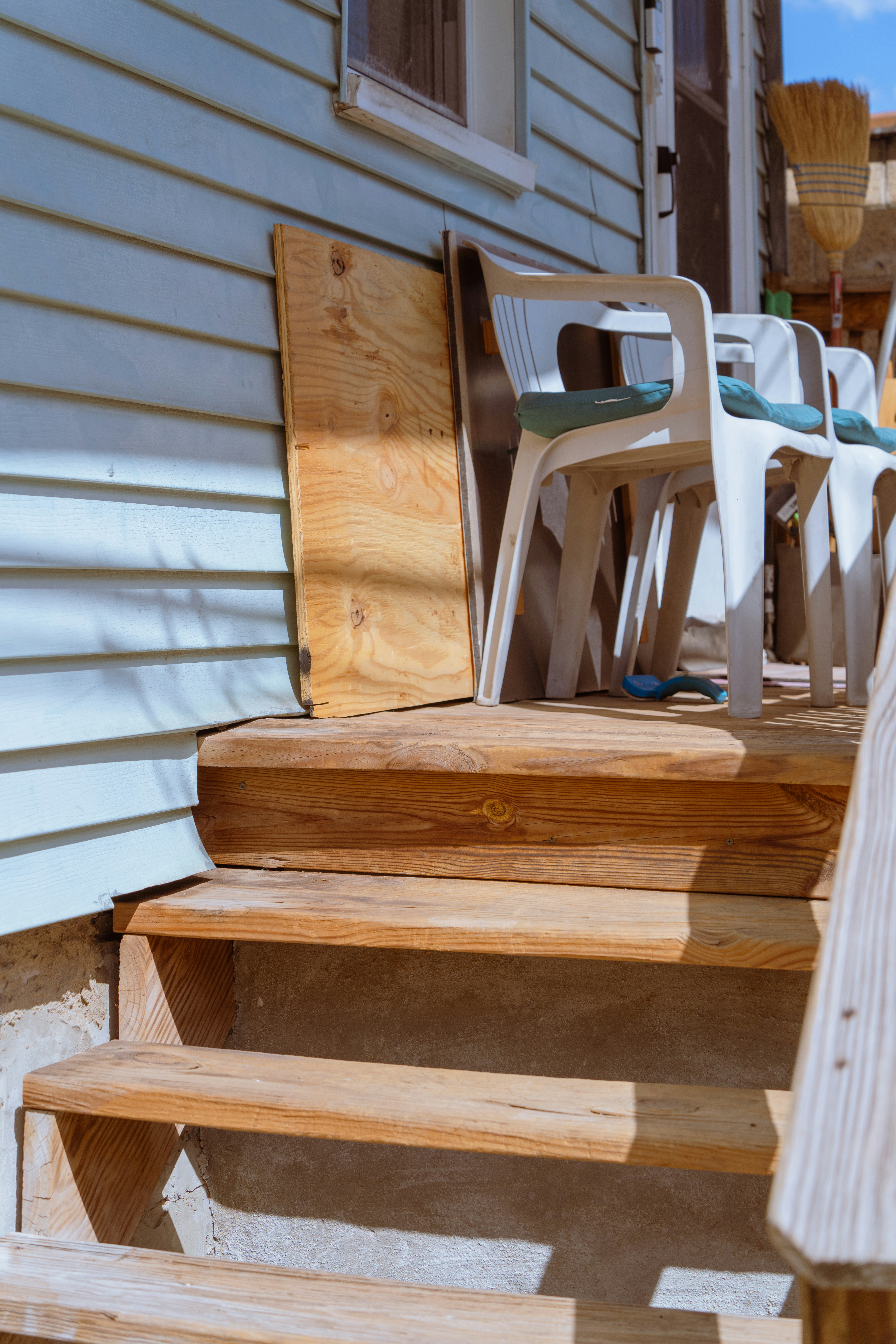 Teal Cushions on Weathered Steps: A Quiet Porch Moment
