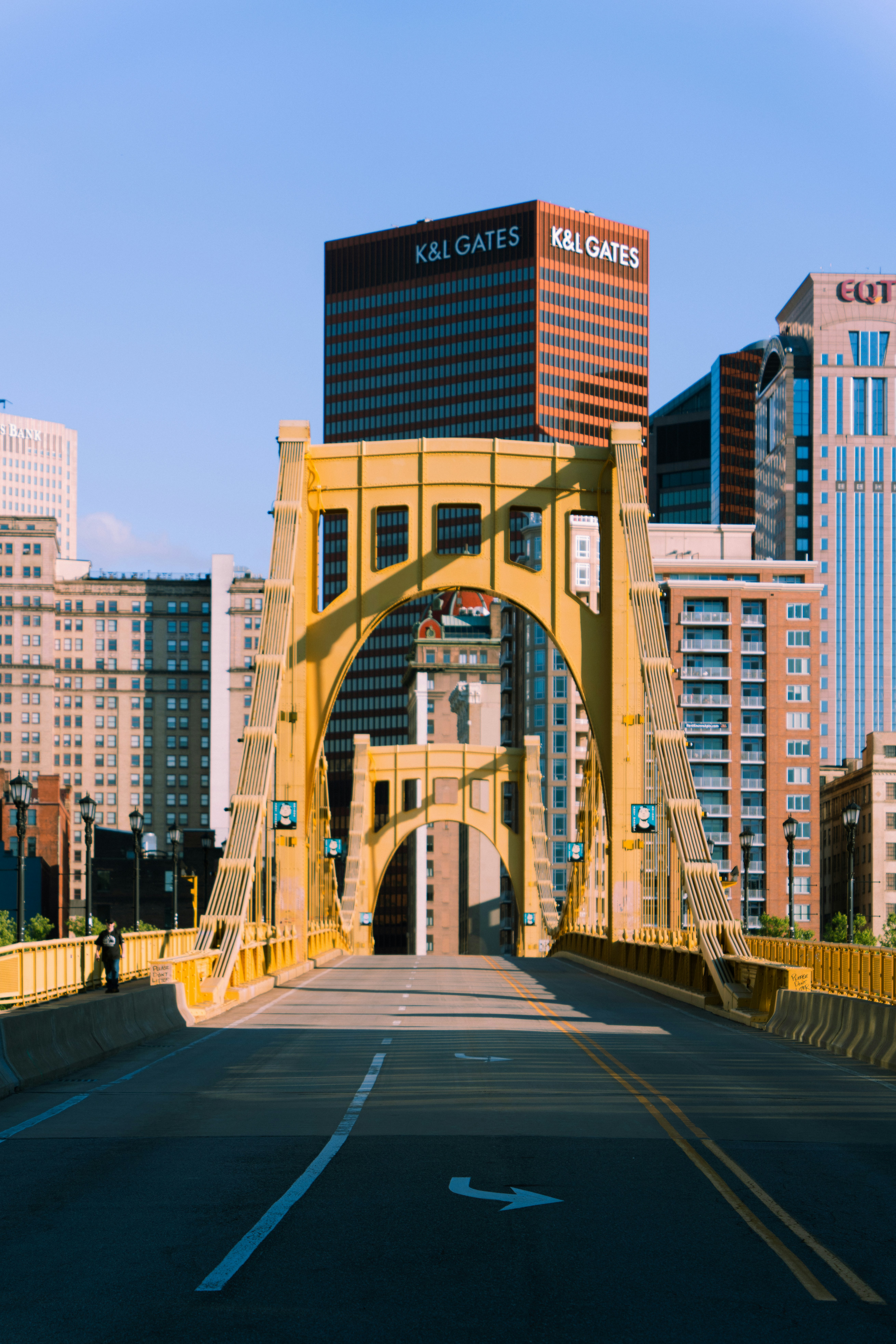 Golden Archways: A City Bridge Stretched Under a Clear Blue Sky