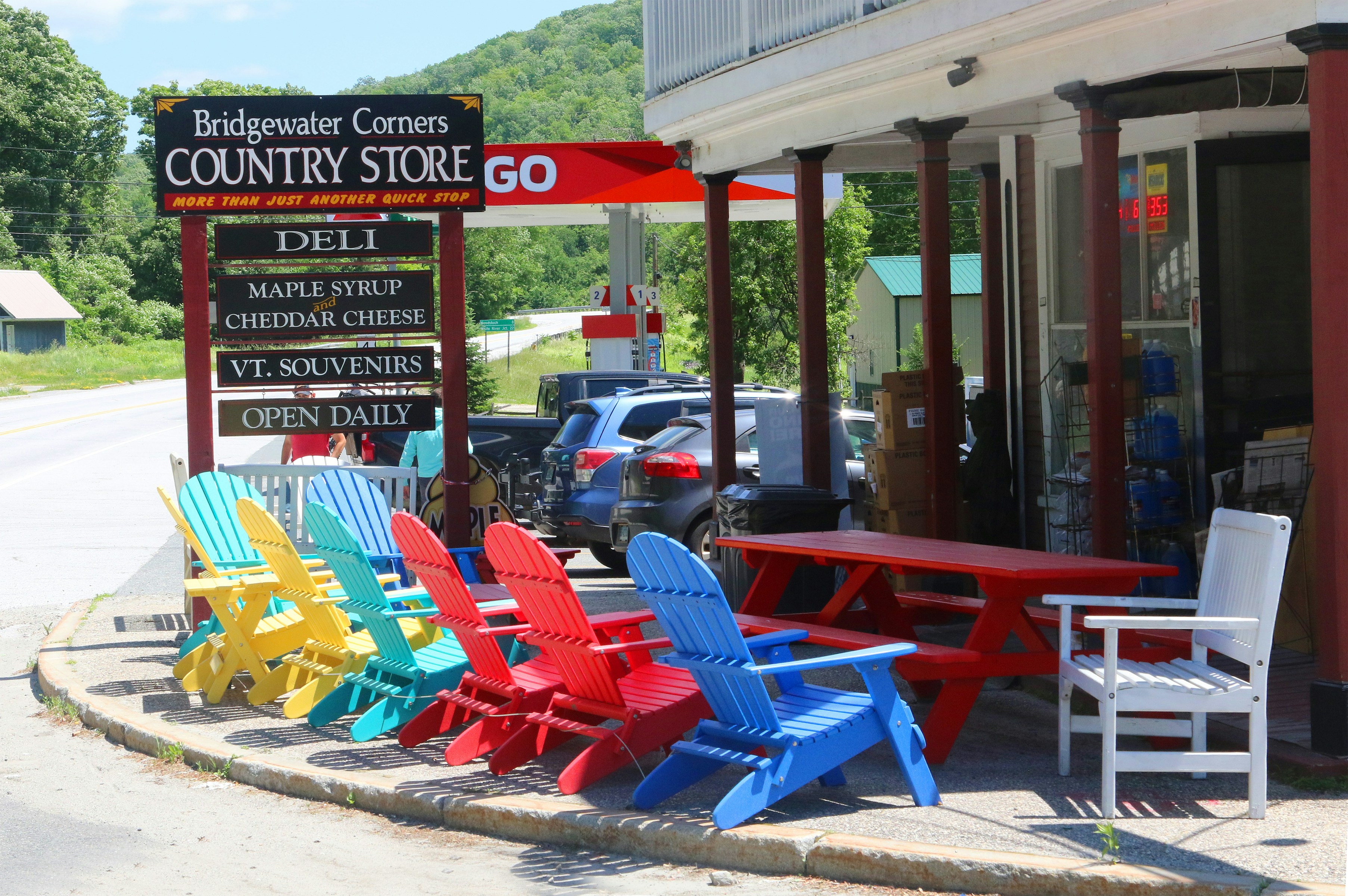 Bright Adirondack Row: Colorful Chairs Outside a Small-Town Deli