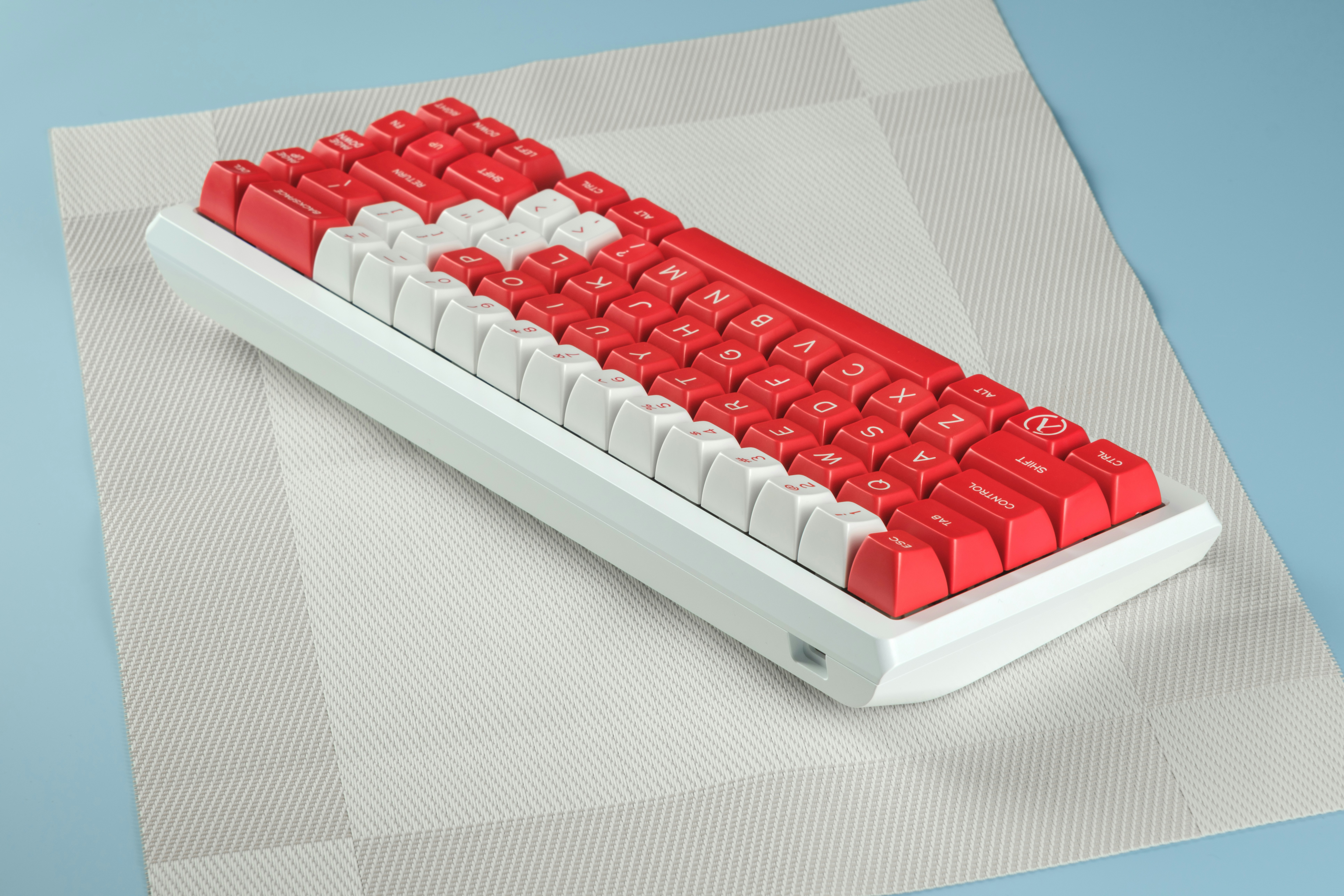 A red and white keyboard sitting on top of a piece of paper photo ...