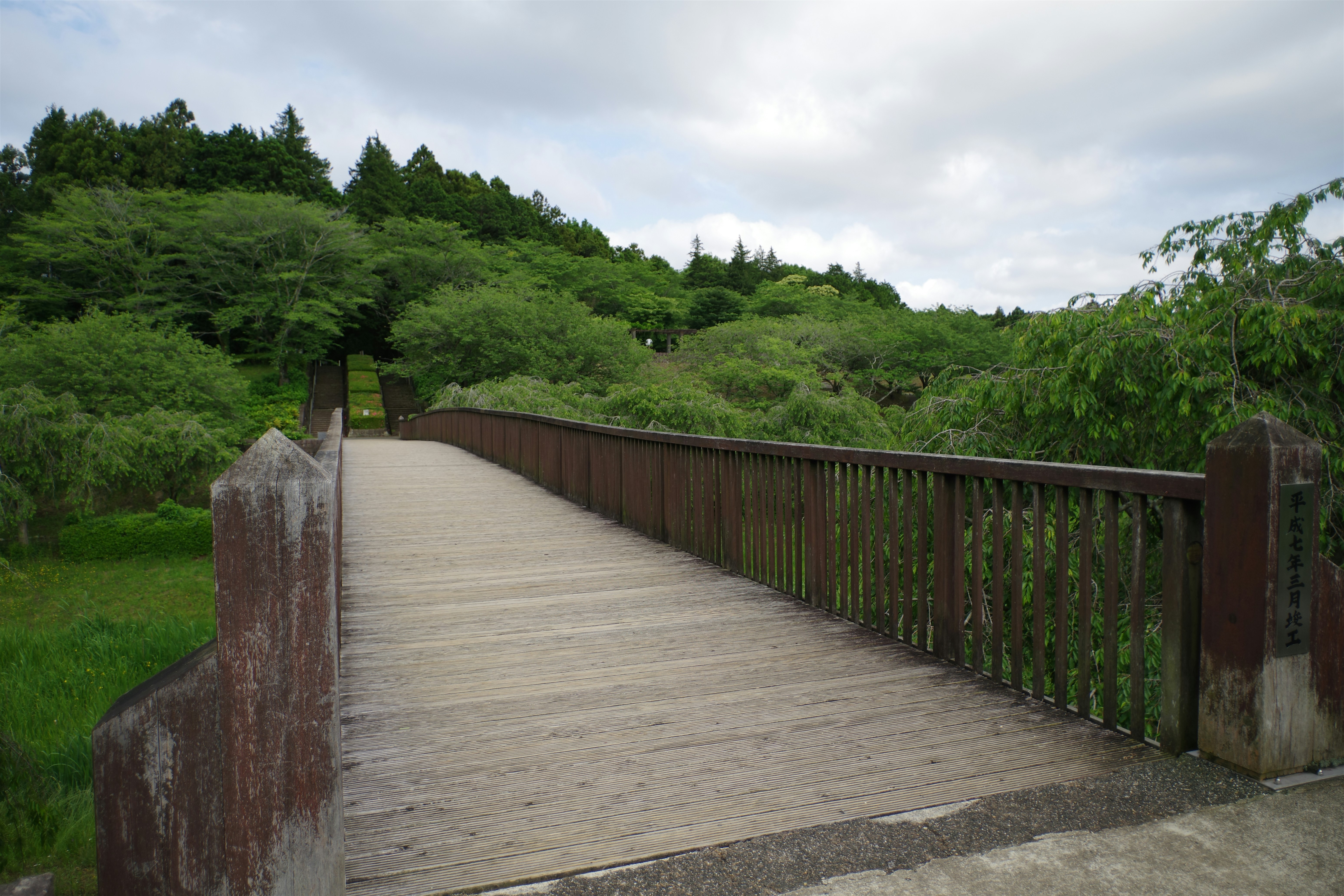 A wooden bridge with a metal railing over it photo – Free Forest Image ...