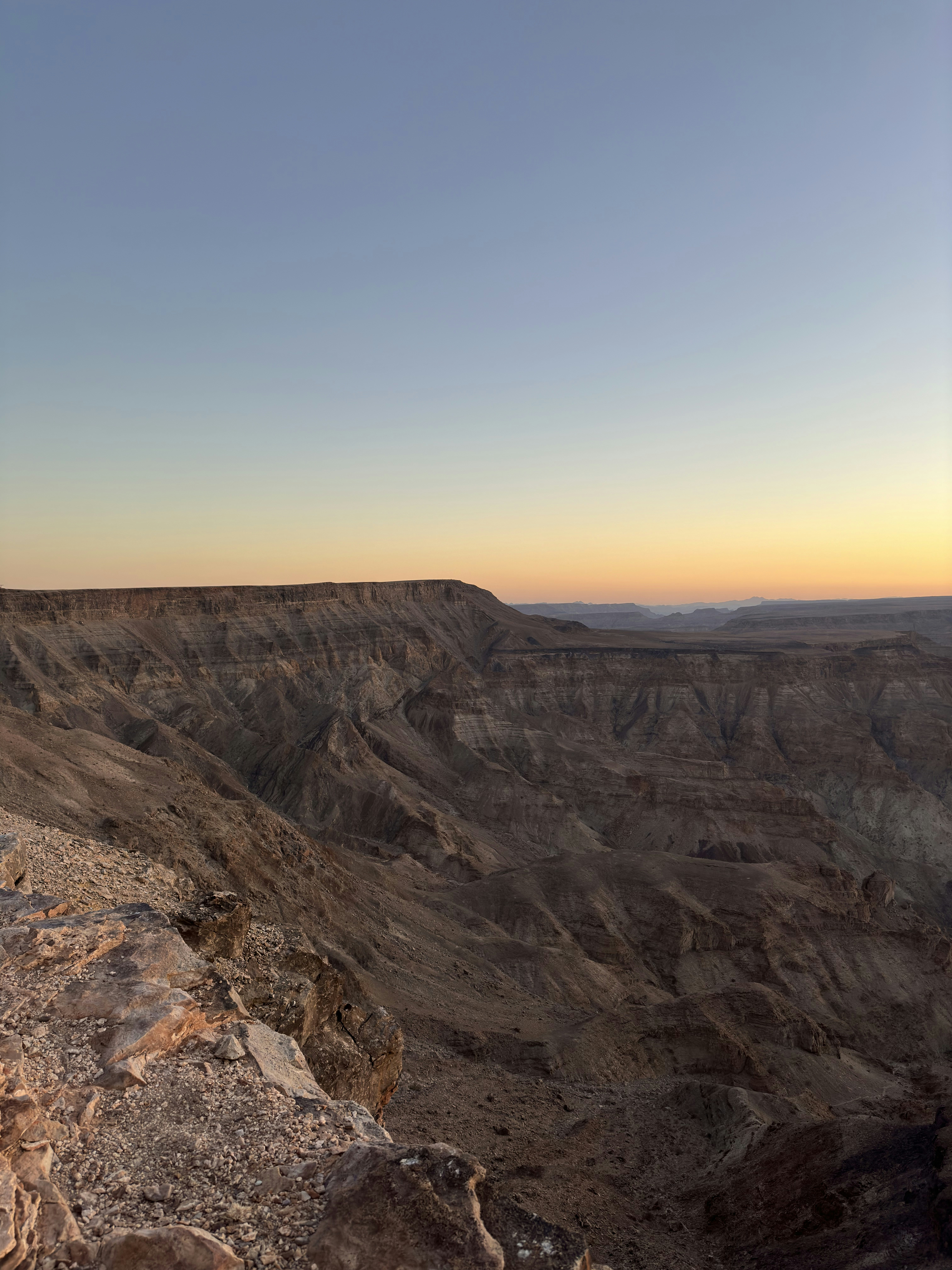 A man standing on top of a large cliff photo – Free Fish river canyon ...