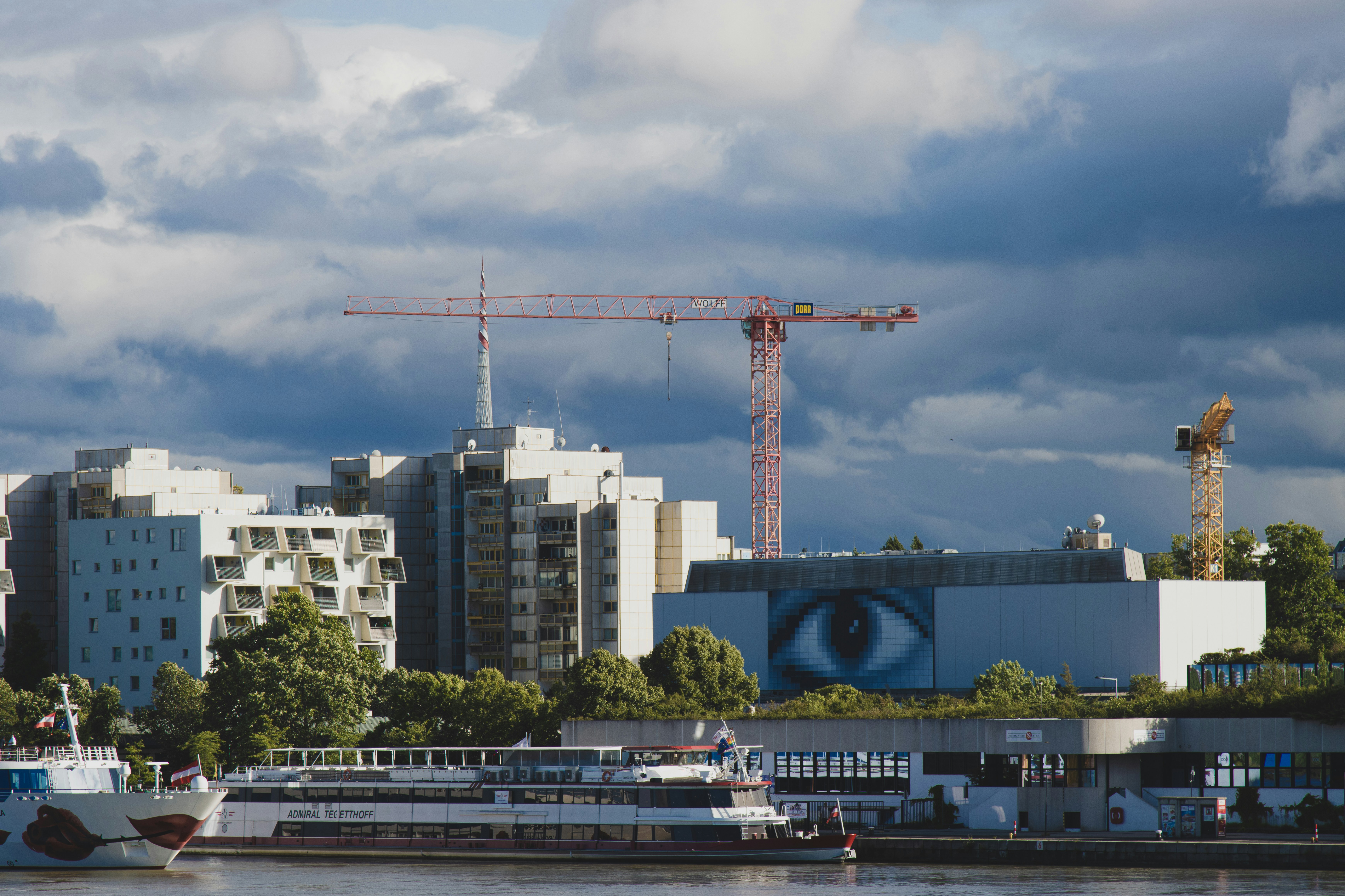 The Blue Eye Over the Waterfront: Cranes, Water, and Modern Blocks