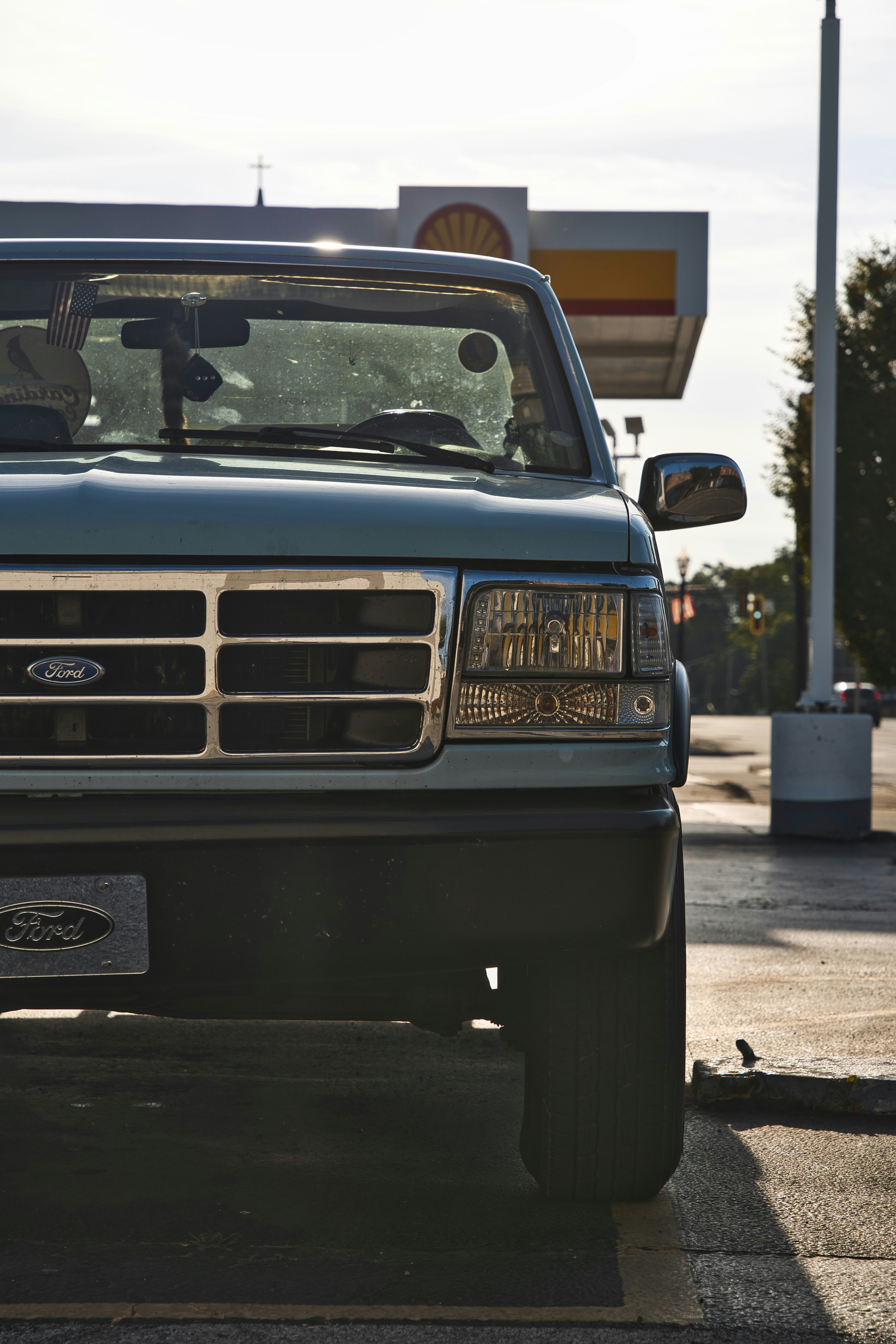 Chrome and Blue: A Vintage Ford Pickup Framed by a Quiet Shell Gas Station