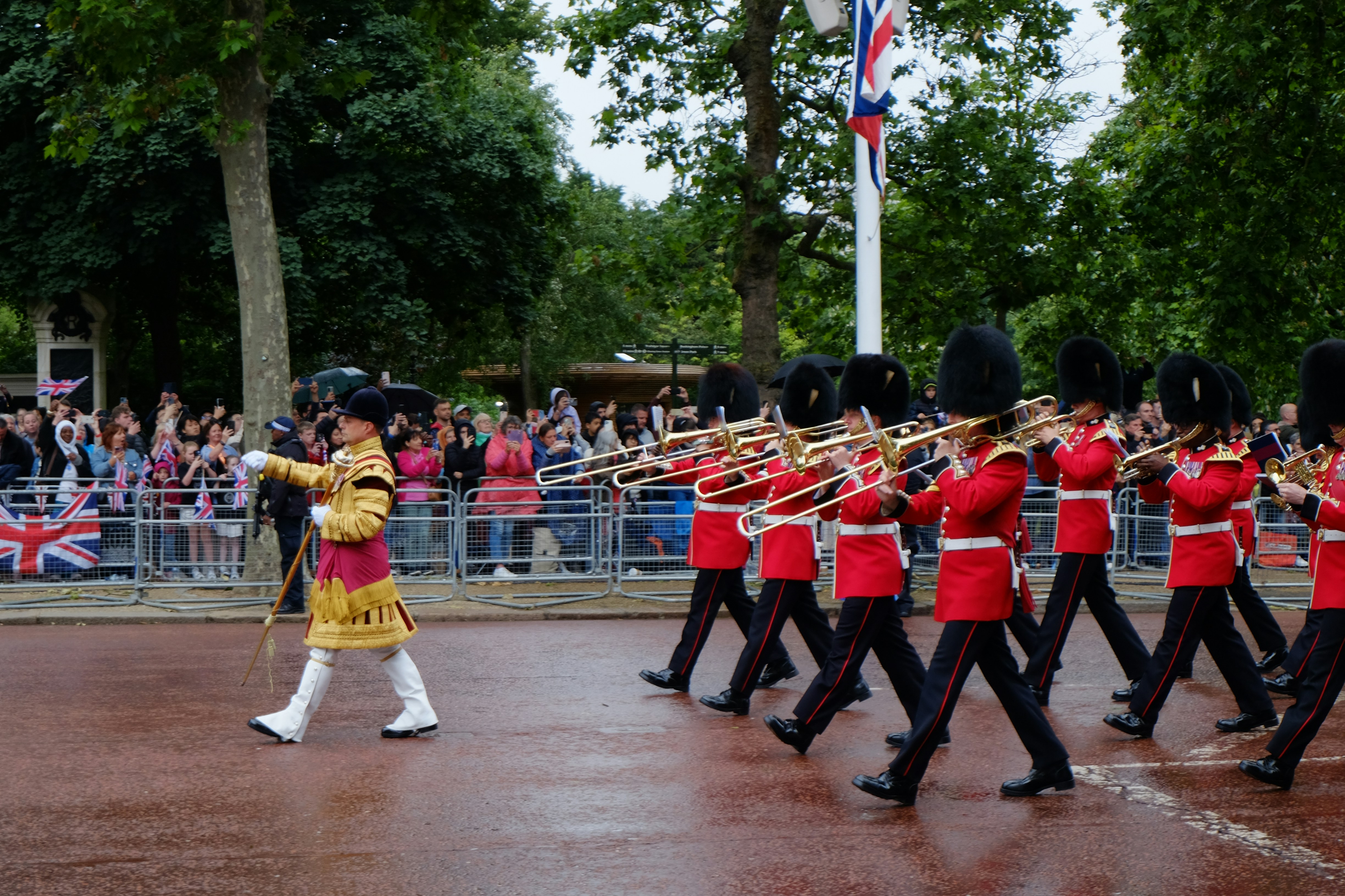 A group of people in uniform marching down a street photo – Free The ...
