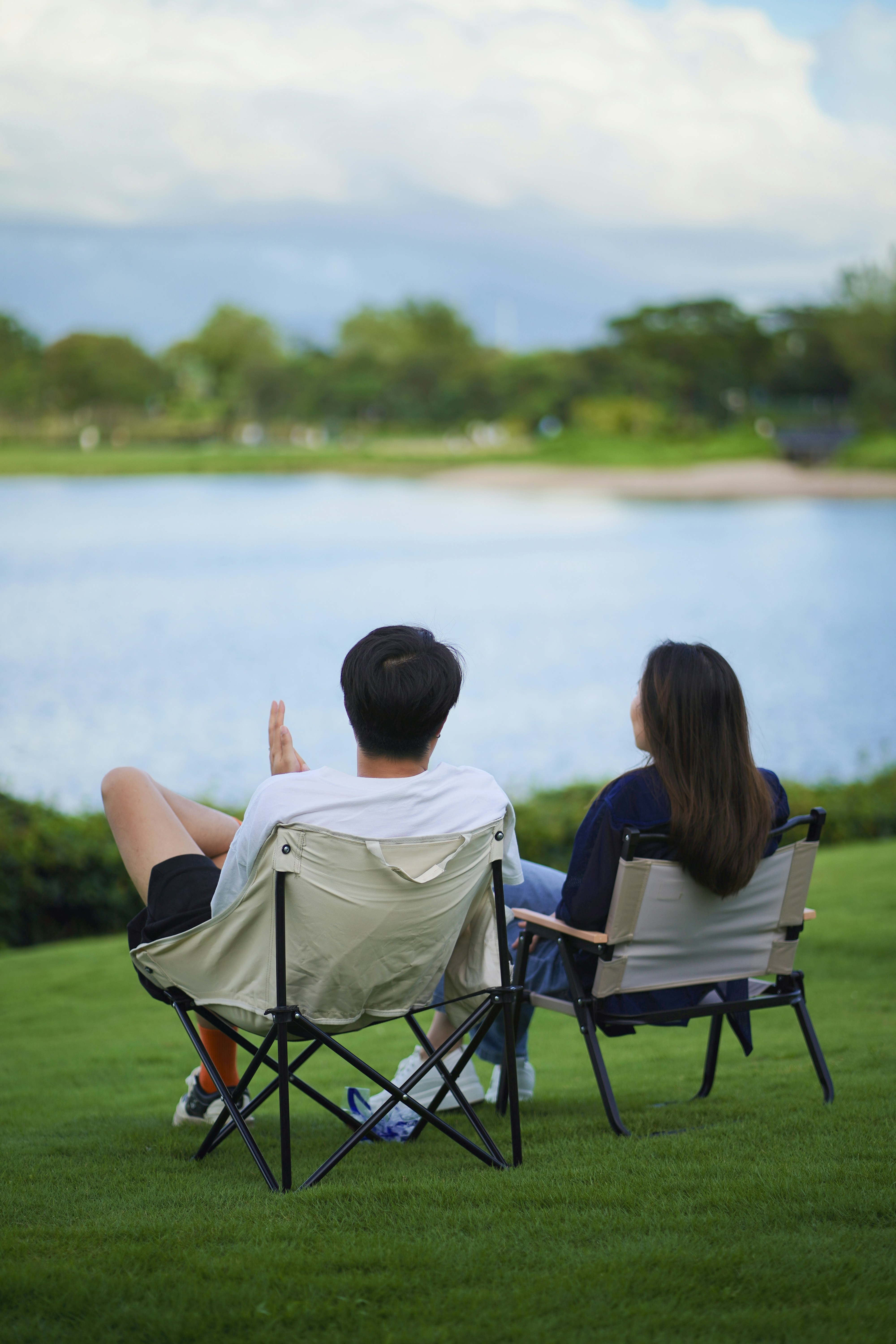 A couple of people sitting in lawn chairs photo – Free Woman Image on ...