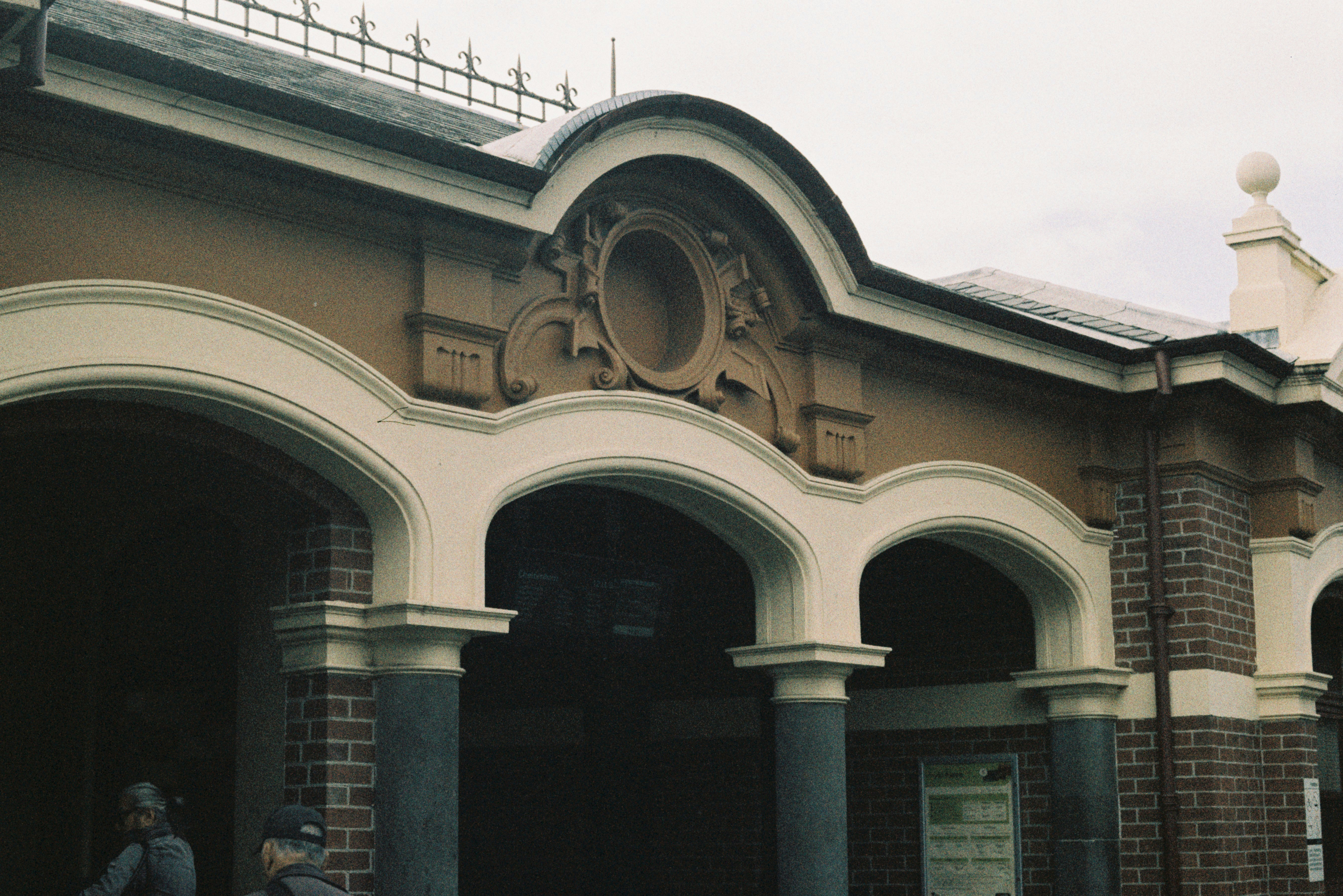 Circular Emblem Nestled in an Arched Brick Arcade
