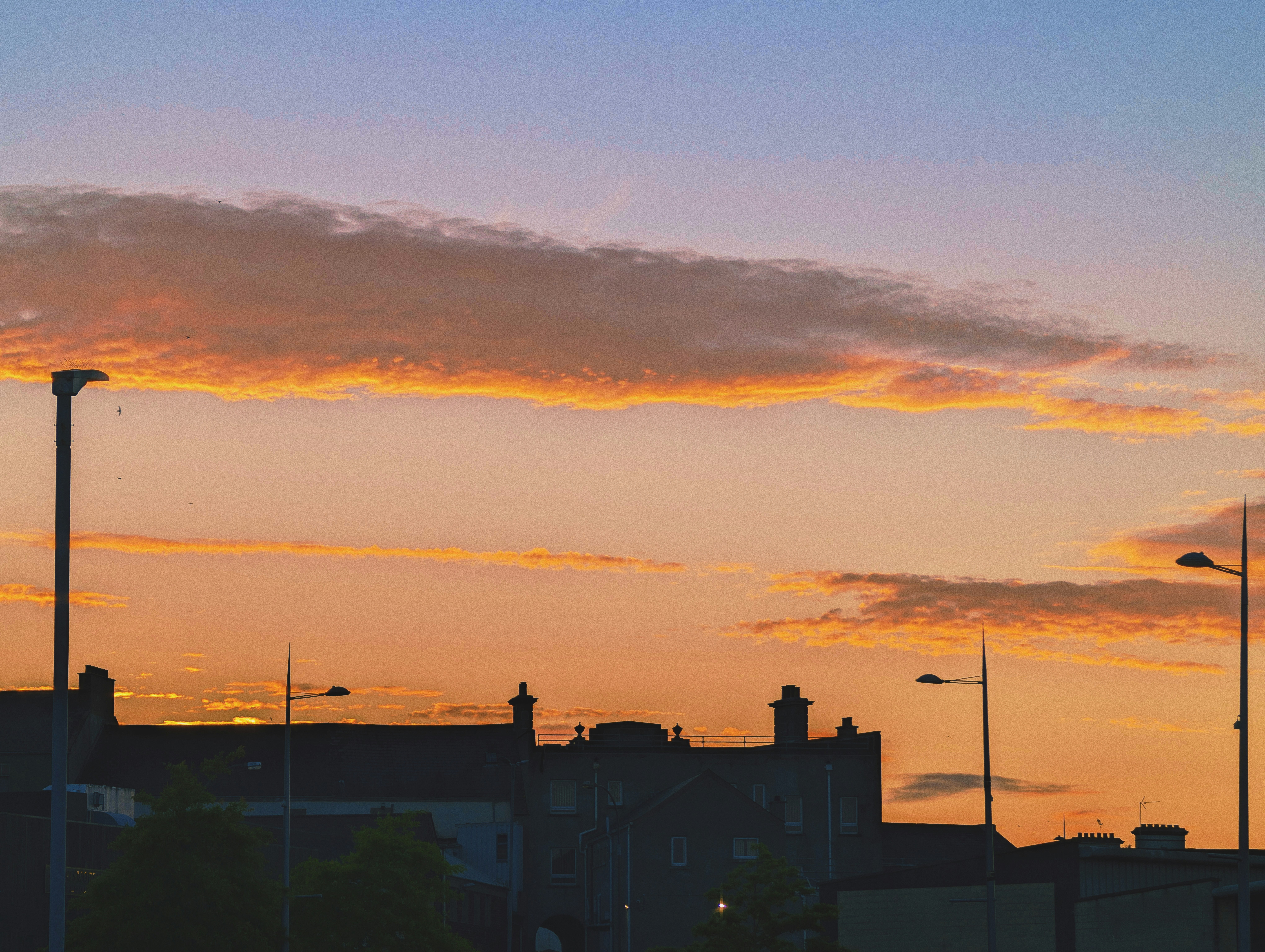 A sunset view of a city with tall buildings photo – Free Sunset Image ...