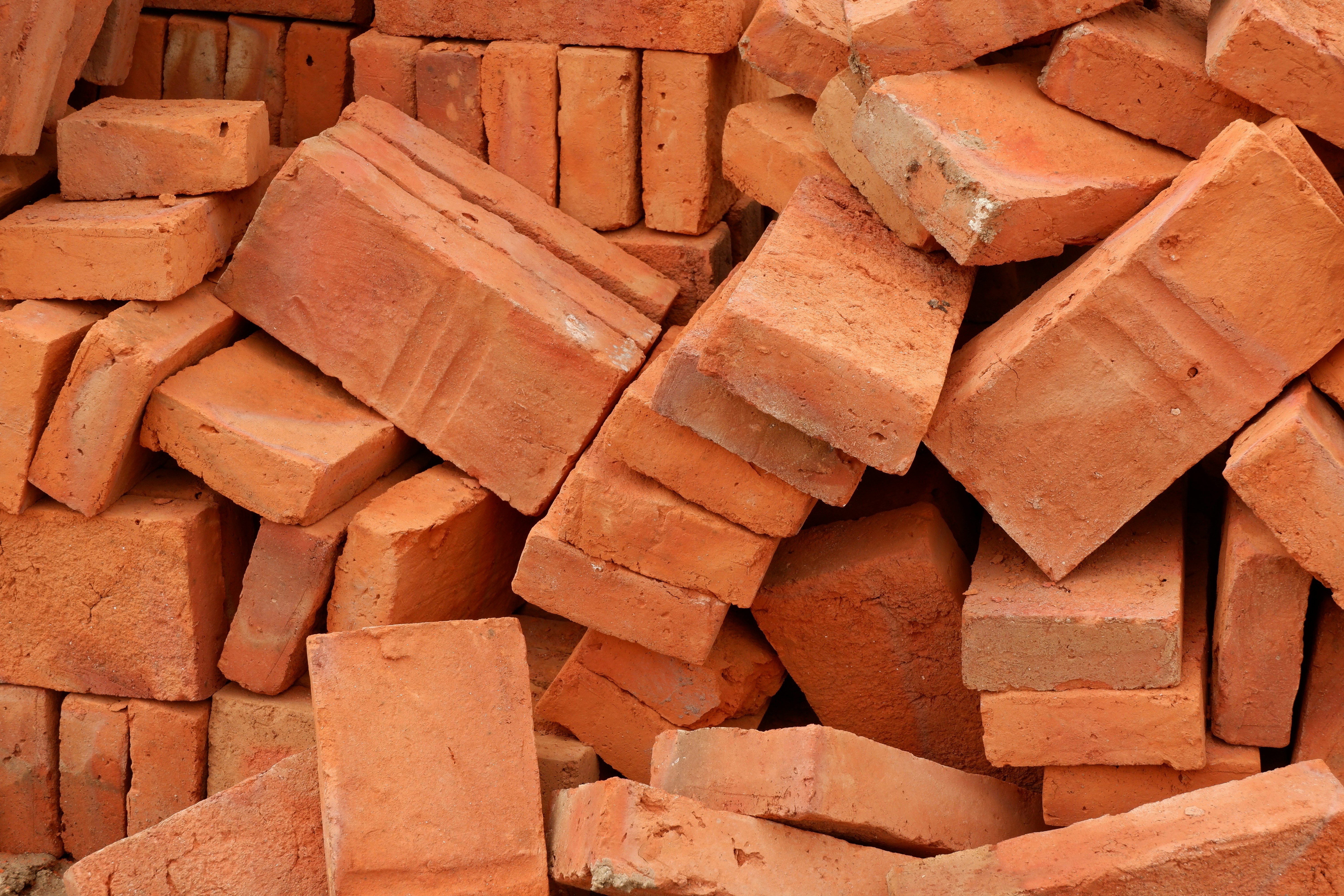Terracotta Tangle: Close-Up of Stacked Bricks in Warm Light