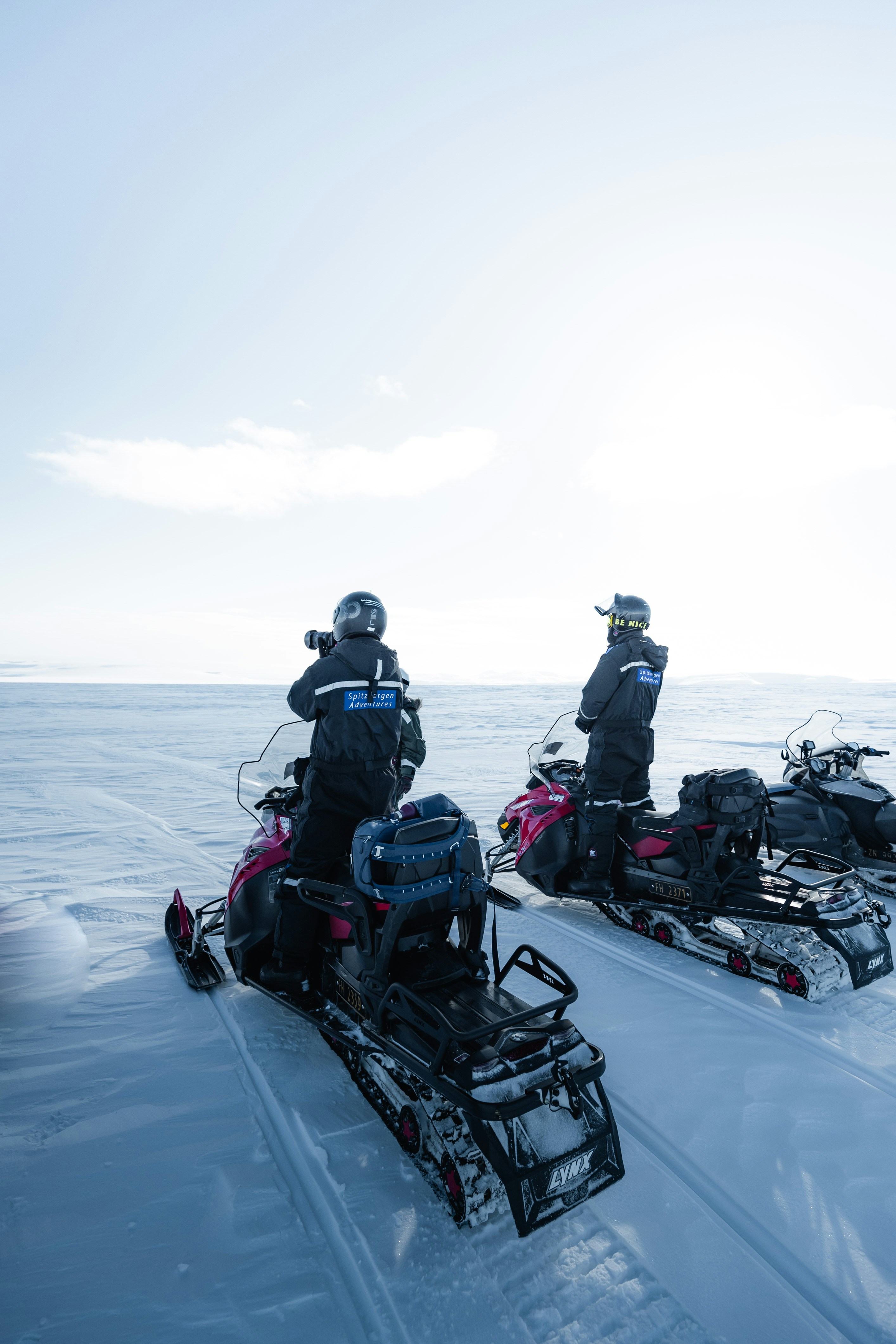 A group of people on snowmobiles in the snow photo – Free Nature Image ...