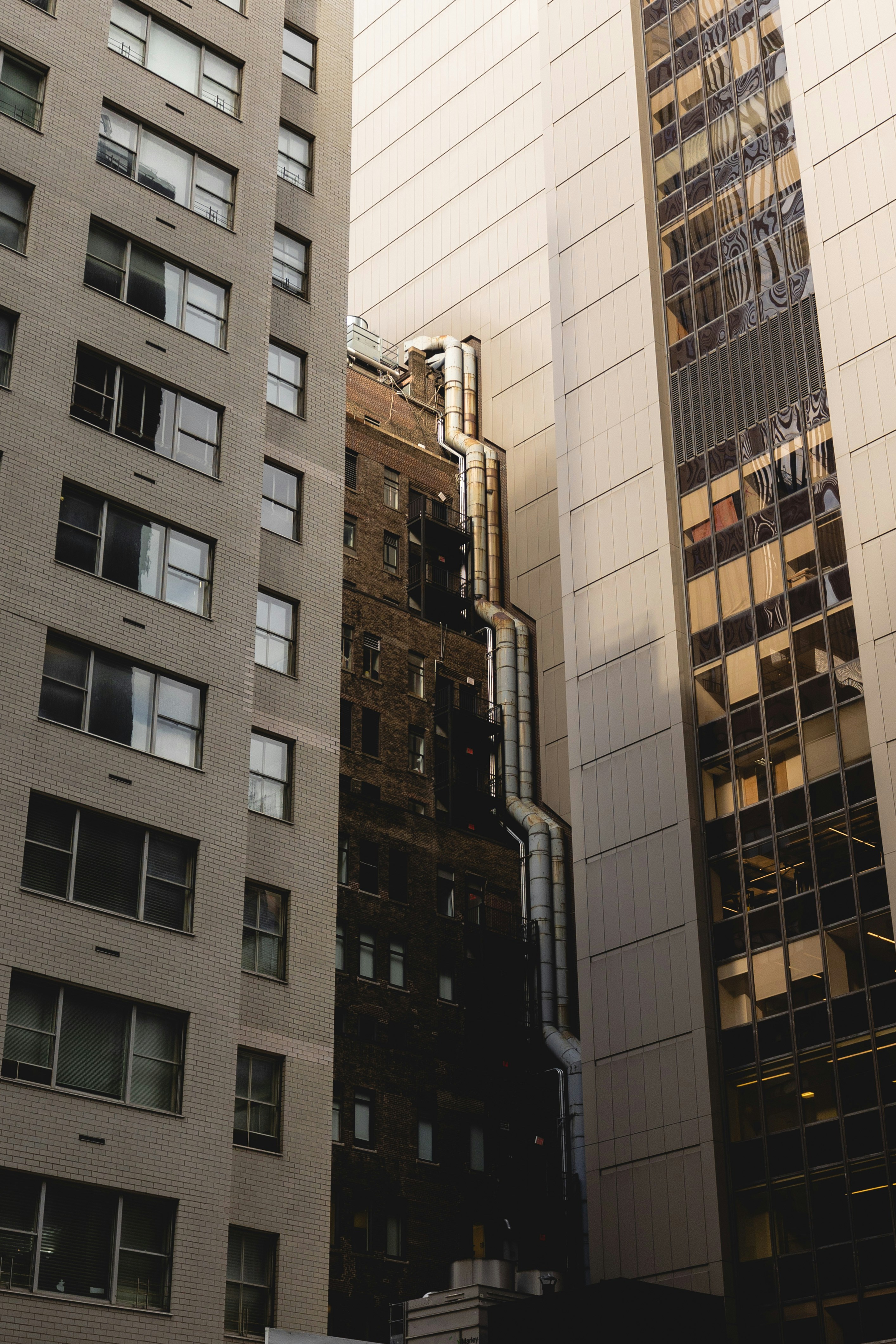 A tall building next to another tall building photo – Free Apartment ...
