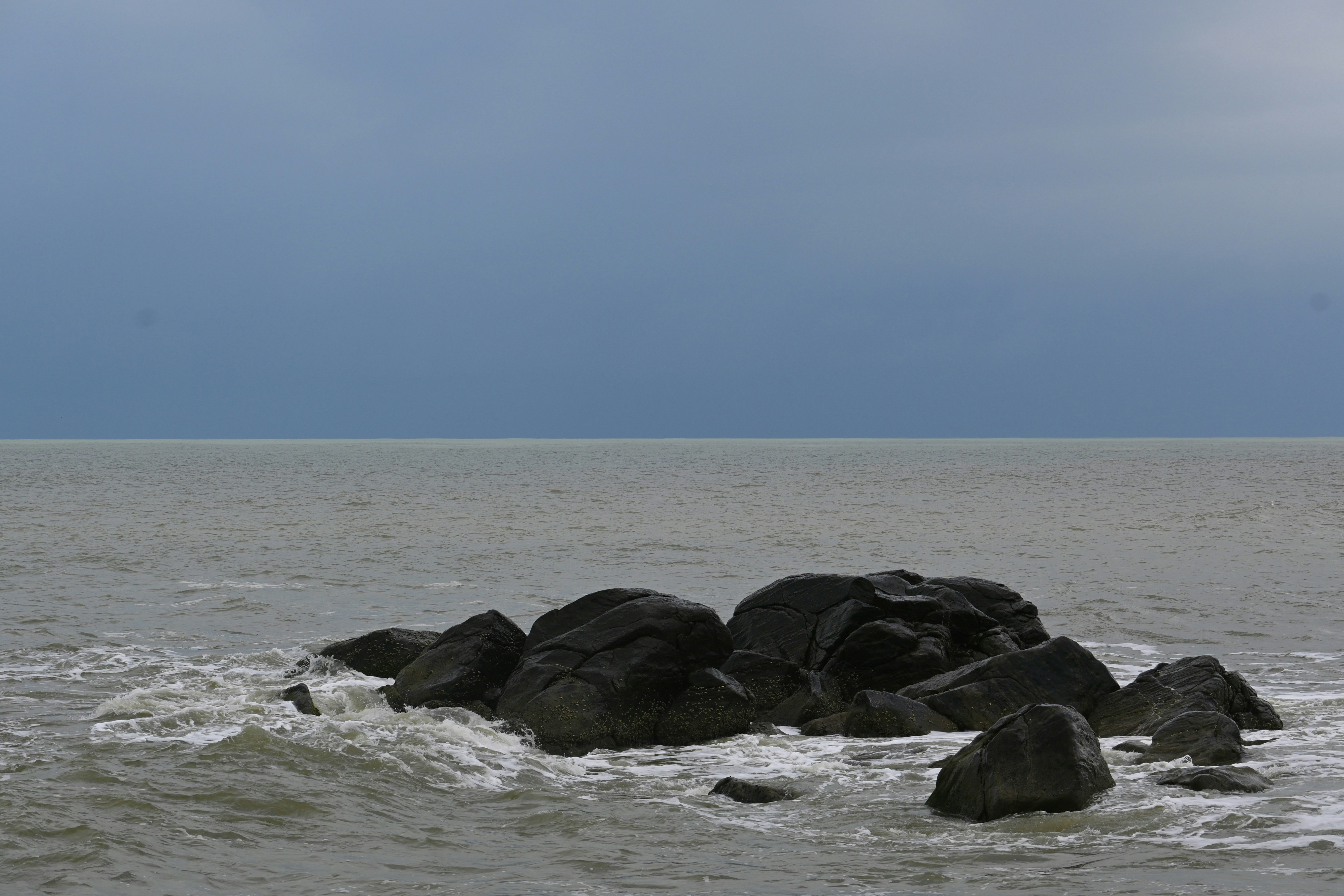 Split in half. Rocks at Chembirika beach. Shot from Kasaragod in Kerala, India.