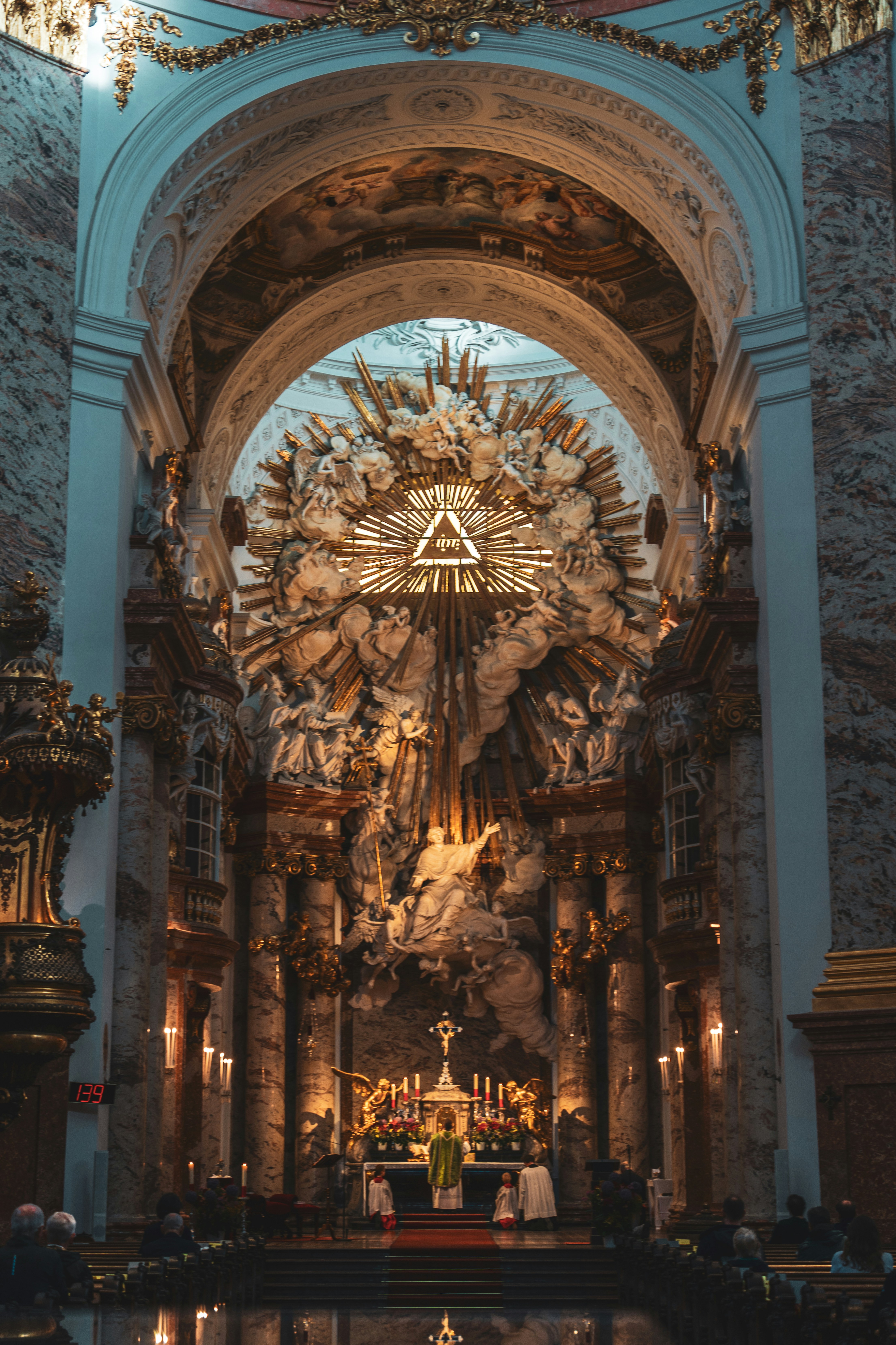 Sunburst Altarpiece: Marble Cathedral's Golden Radiance Above the Altar