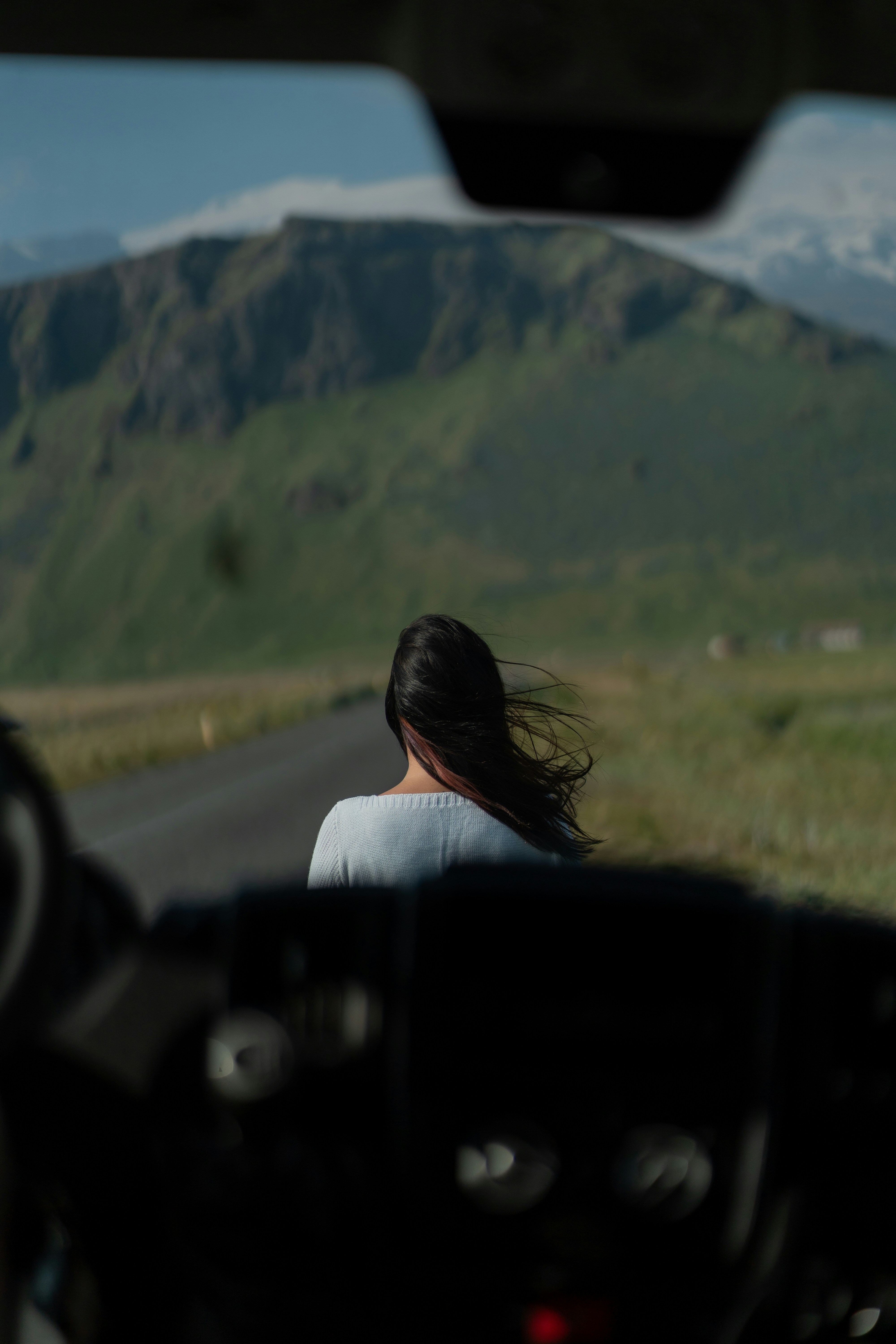 Rear-View on an Open Road Toward Verdant Peaks