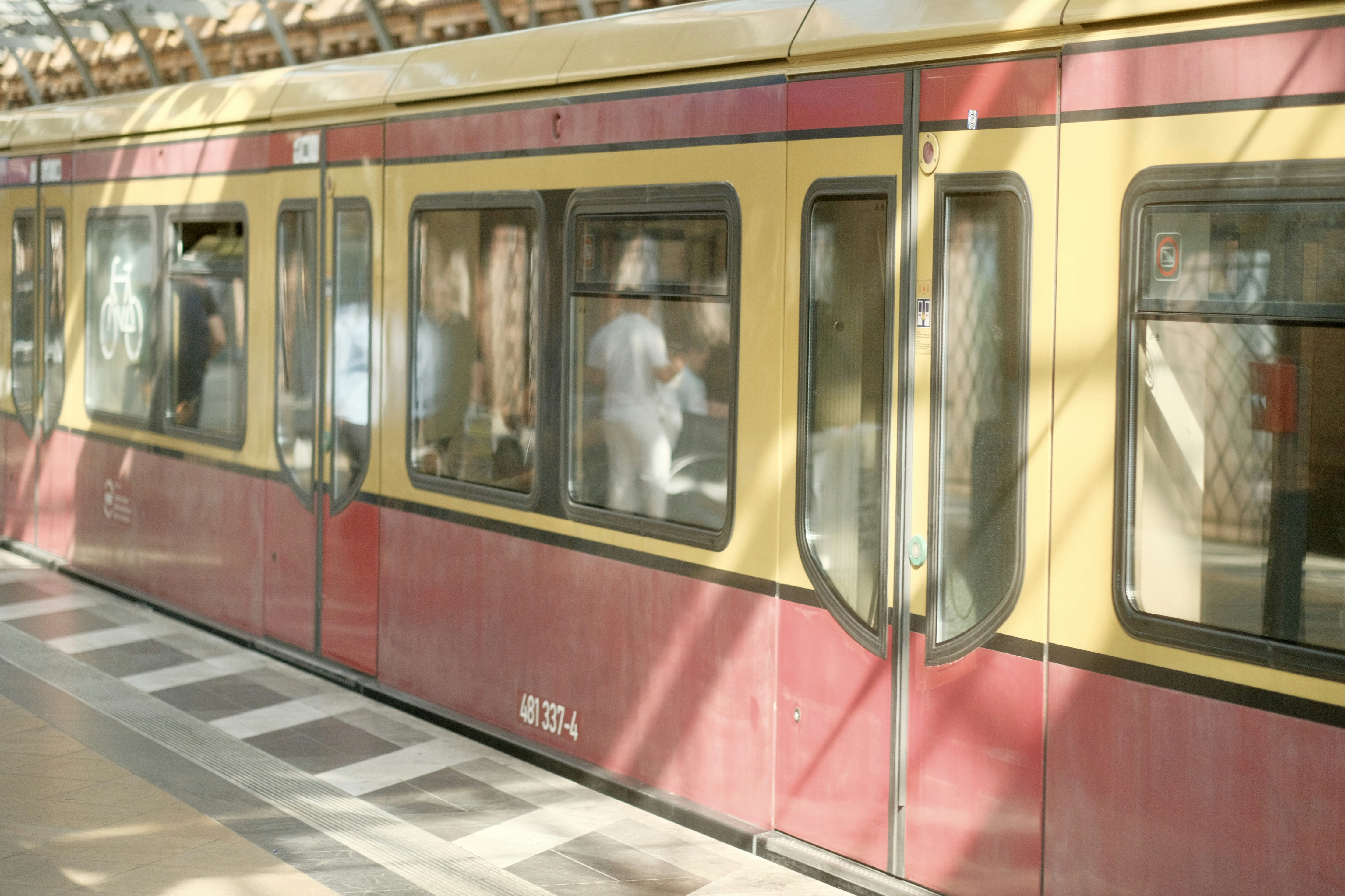 A red and yellow train traveling down train tracks photo – Free Train ...