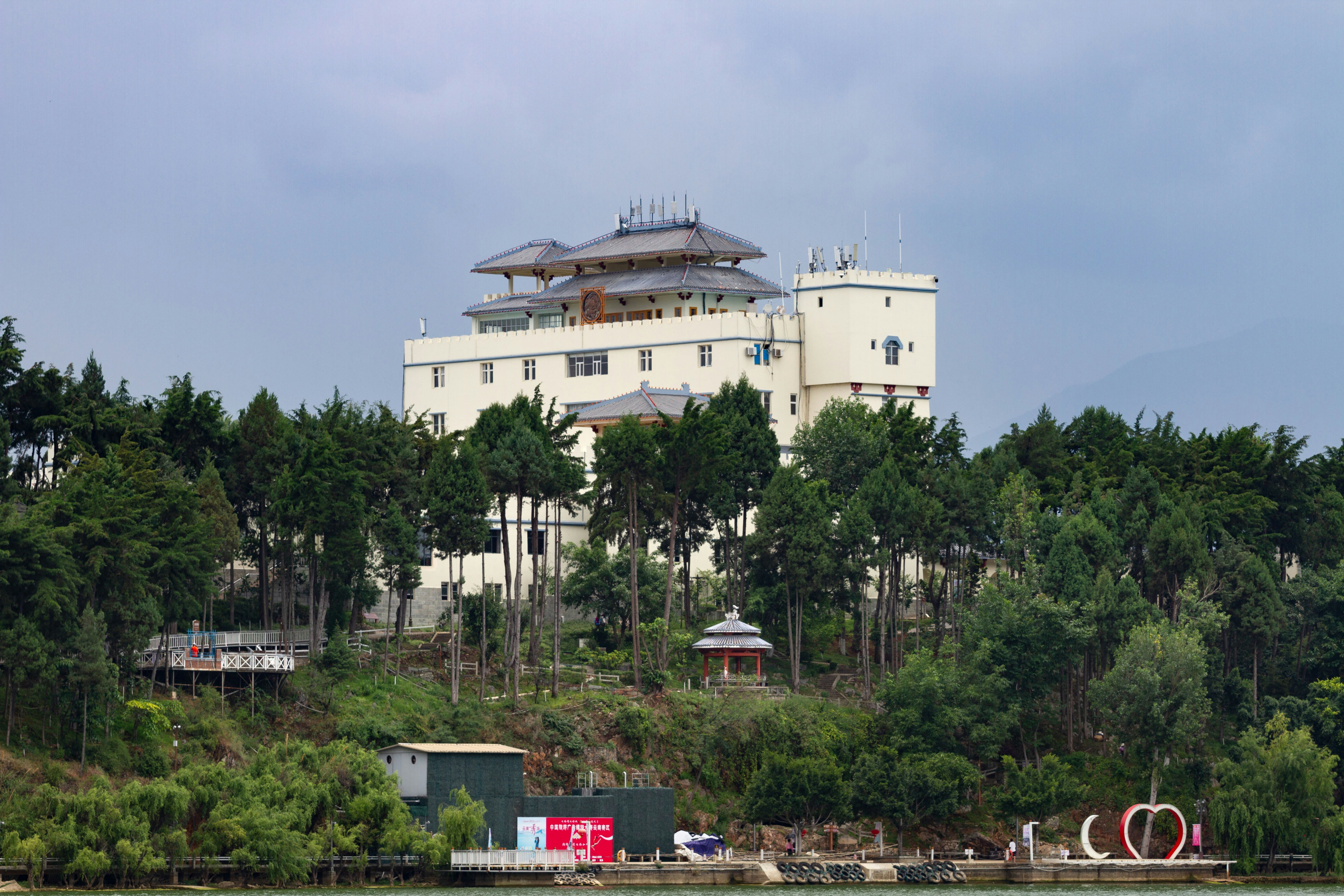Hilltop White Estate Surrounded by Pines Over a Tranquil Waterfront