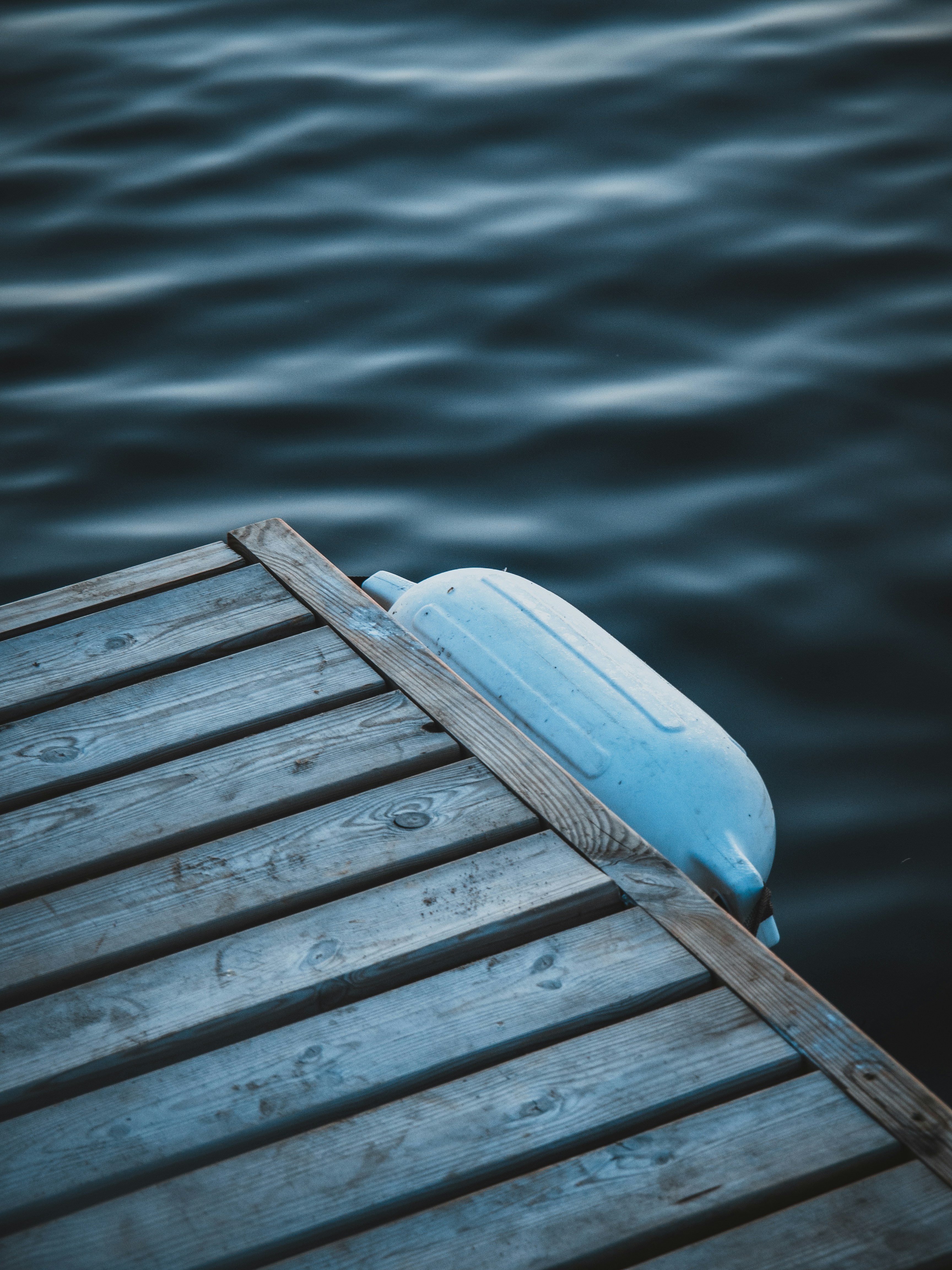 Edge of Calm: A Pale Blue Dinghy at the Dock