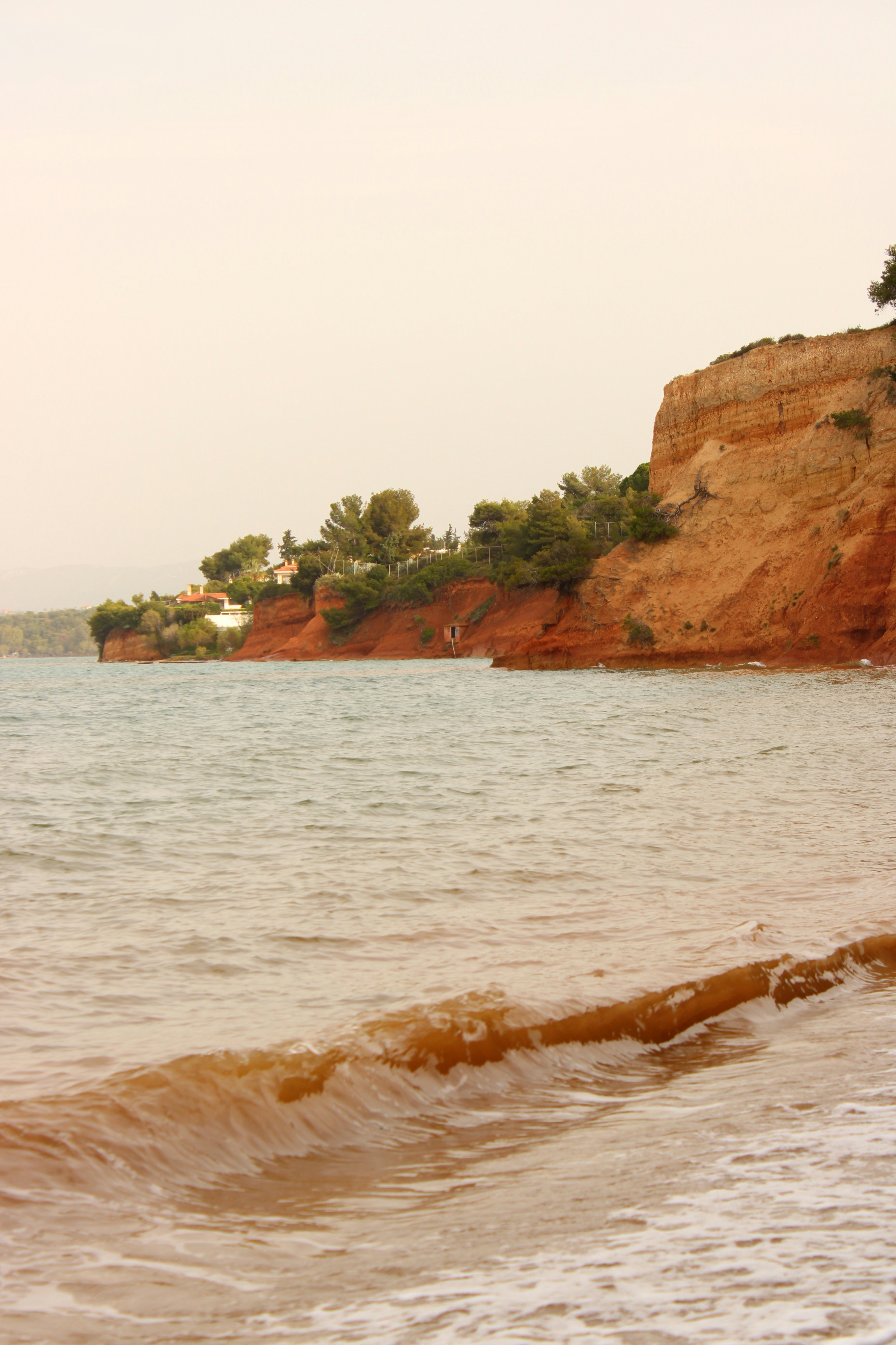 Copper Cliffs Over a Quiet Amber Sea