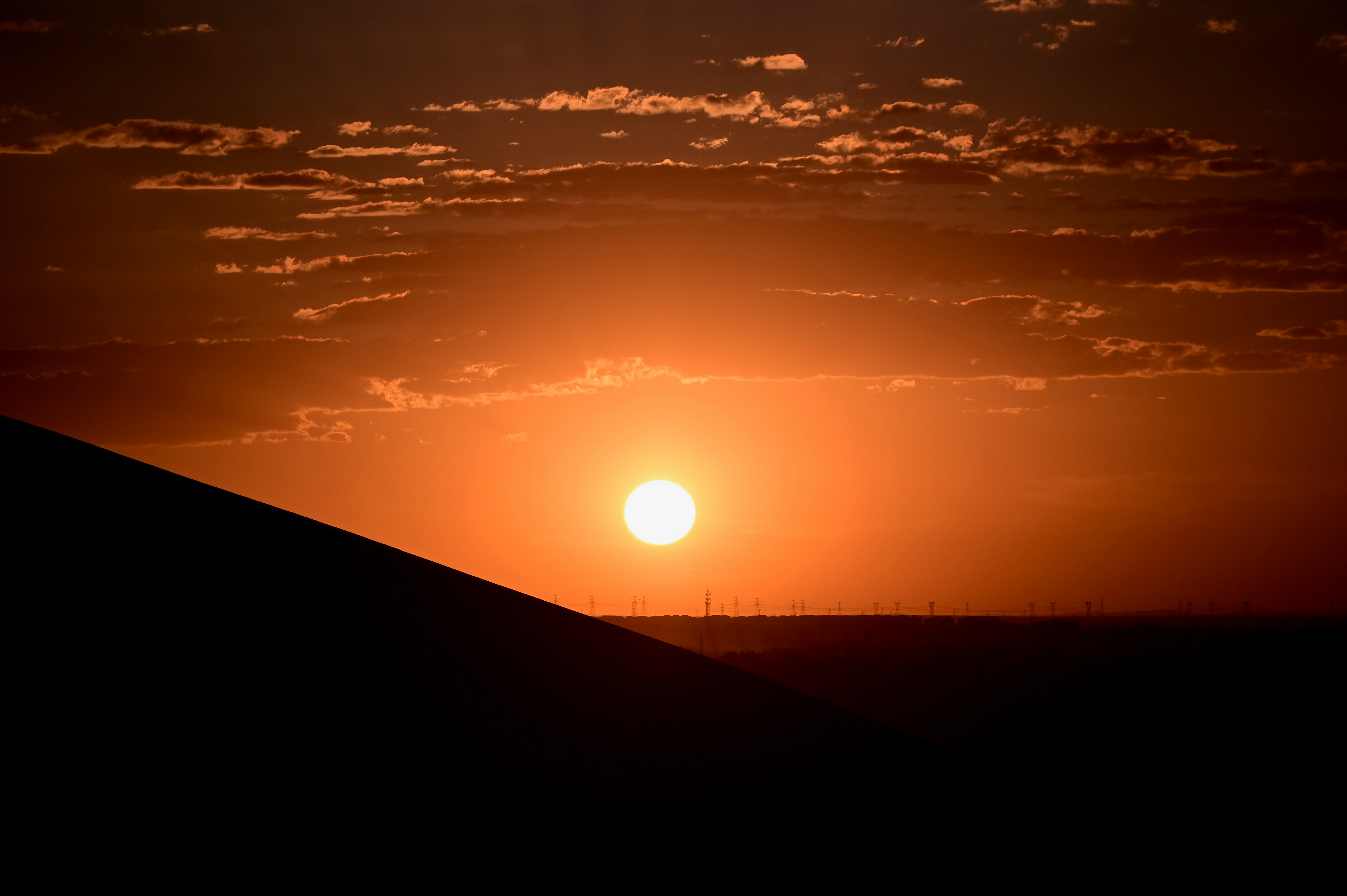 The sun is setting over a hill in the distance photo – Free Dunhuang ...
