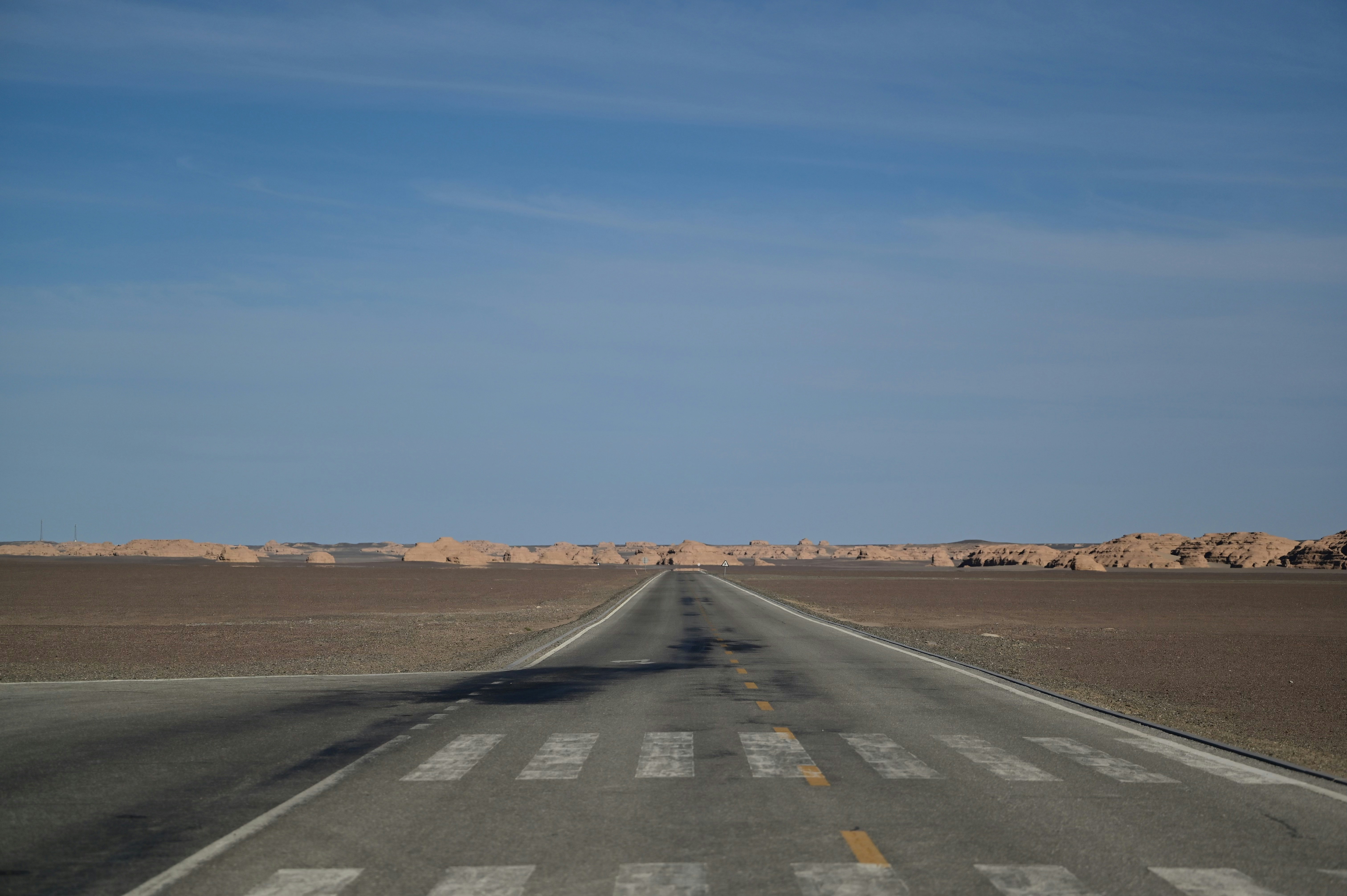 An empty road with a sign painted on it photo – Free Grey Image on Unsplash