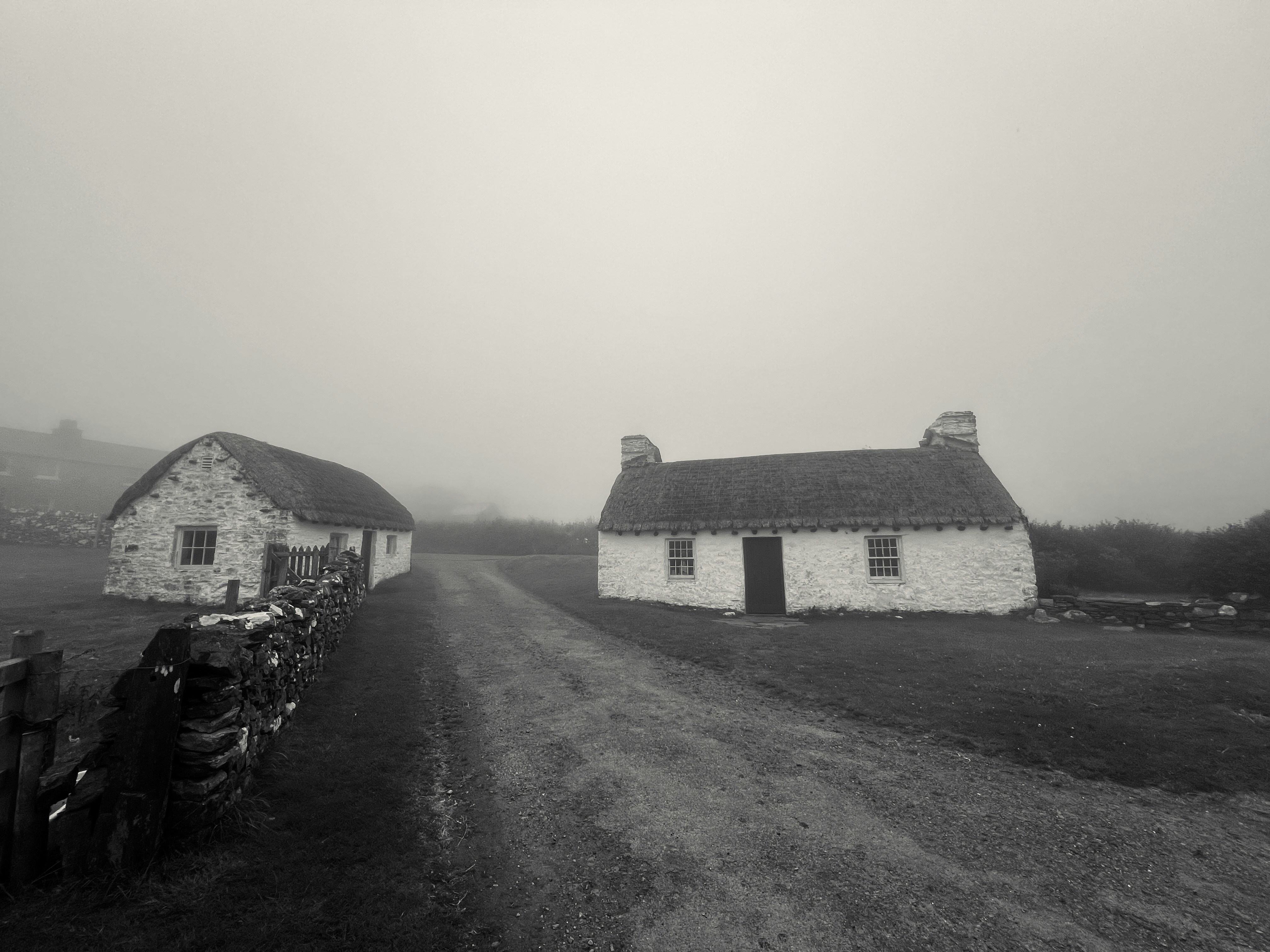 Mist-Lined Track Between Stone Cottages