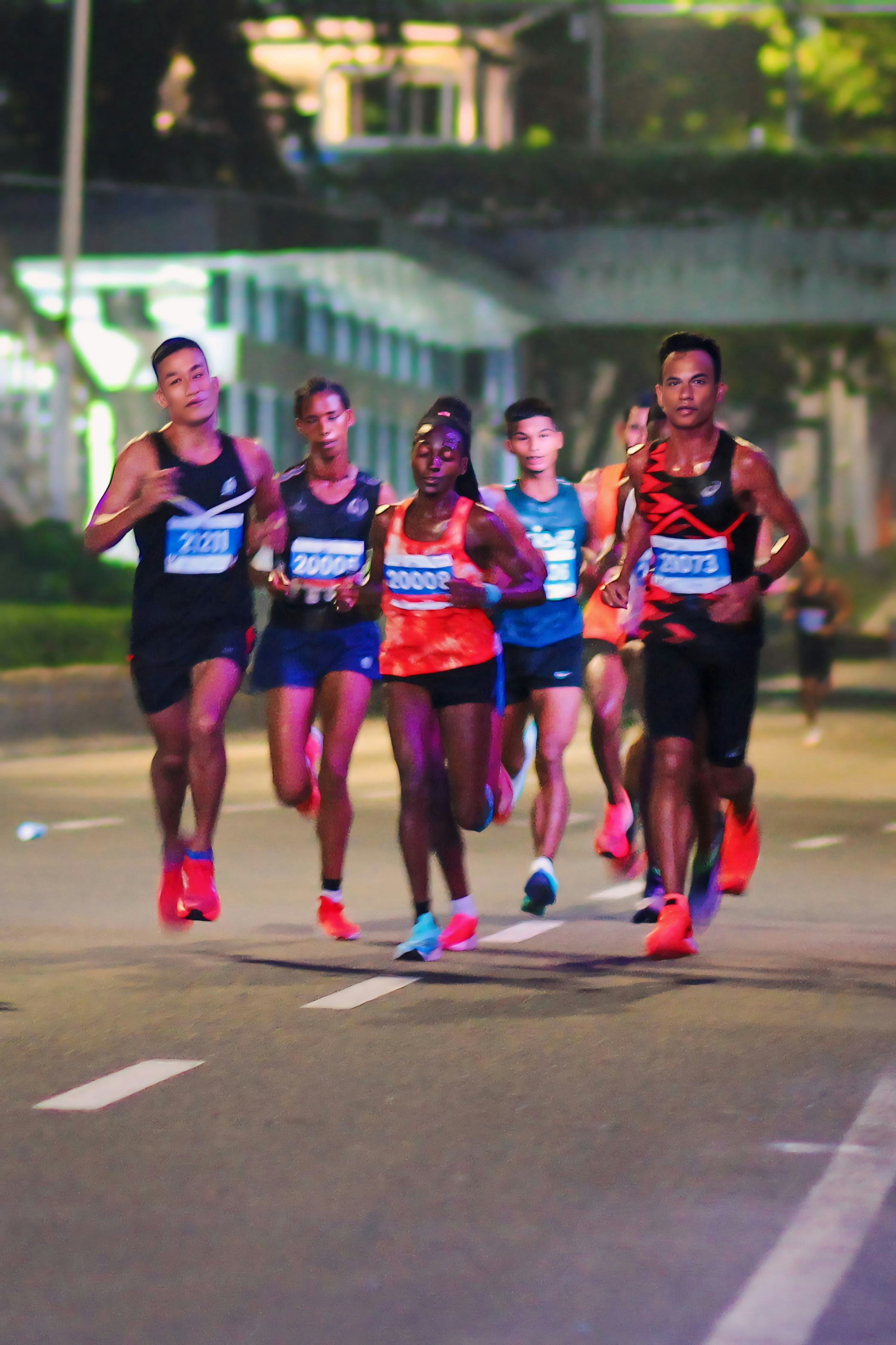 A group of people running down a street at night photo – Free Jakarta ...