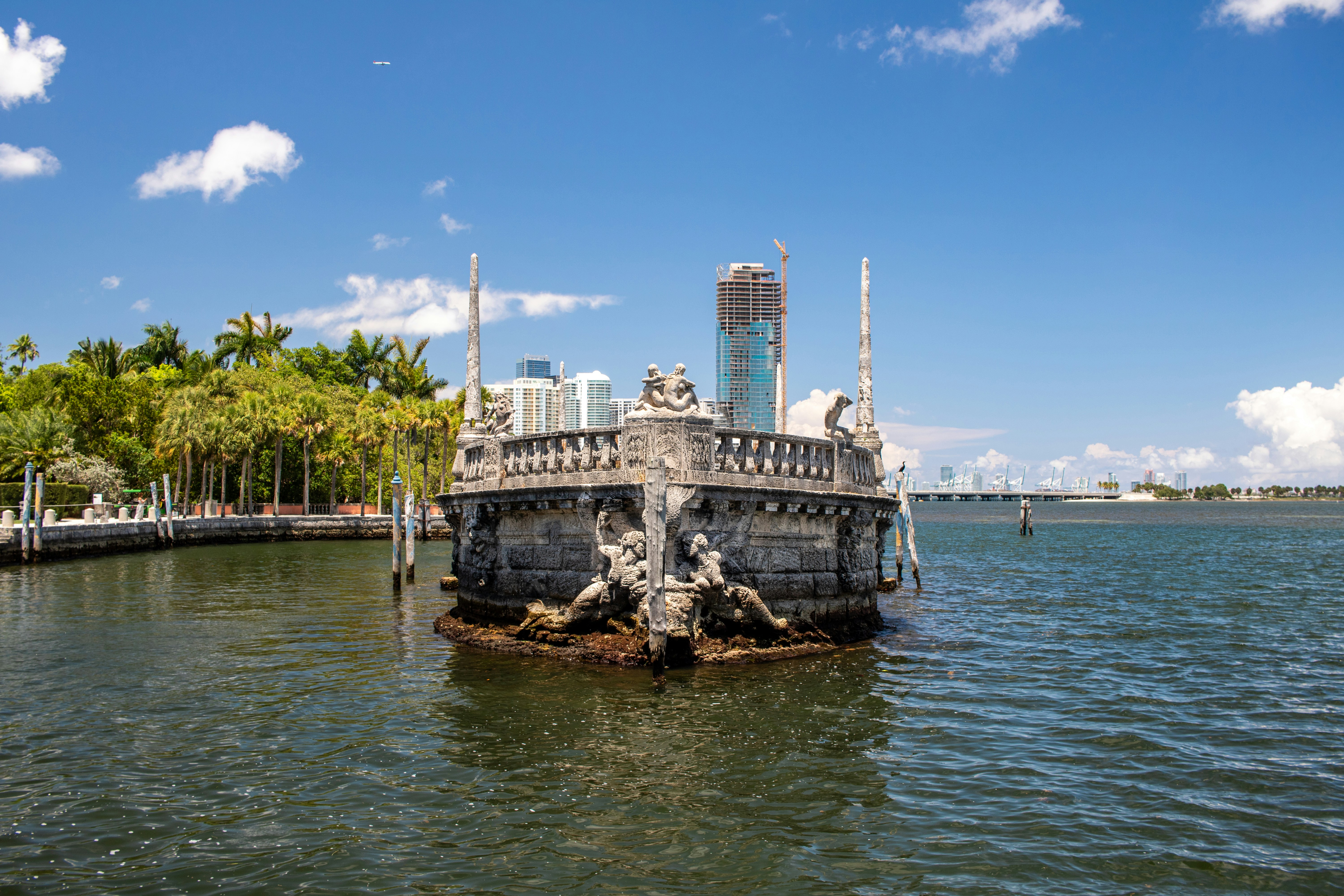 The waterfront at Vizcaya Museum and Gardens in Miami features a unique stone barge designed to resemble a ship. Built to create a picturesque view and act as a breakwater, this ship-like structure enhances the estate’s Mediterranean Revival aesthetic. The barge, adorned with sculptures and decorative elements, appears to be a stationary vessel docked at the estate, adding to Vizcaya's charm and providing a serene ambiance. This distinctive feature reflects James Deering's vision of blending art with the natural landscape, contributing to the estate’s allure as a historic masterpiece.
