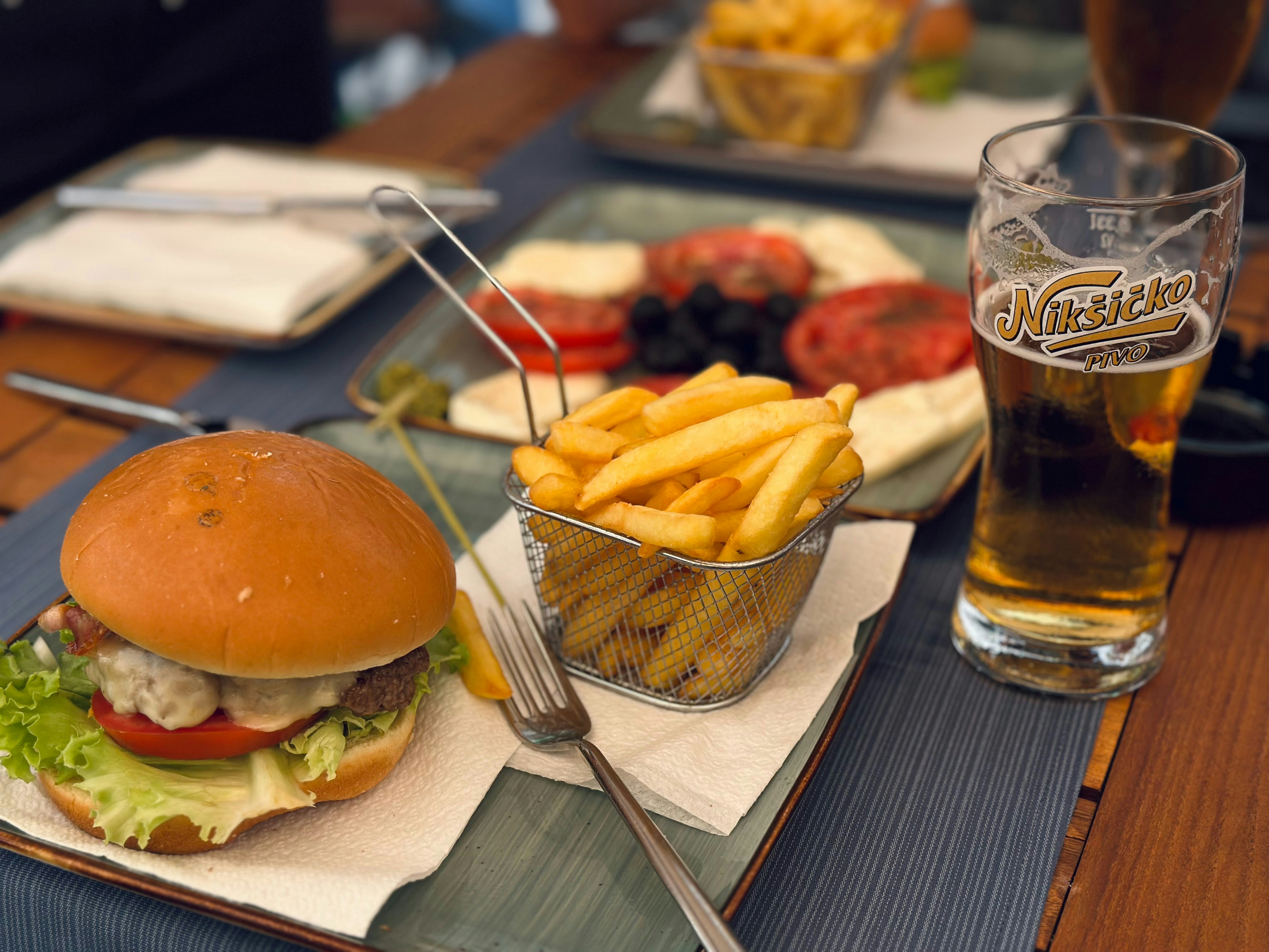 A table topped with a burger and fries
