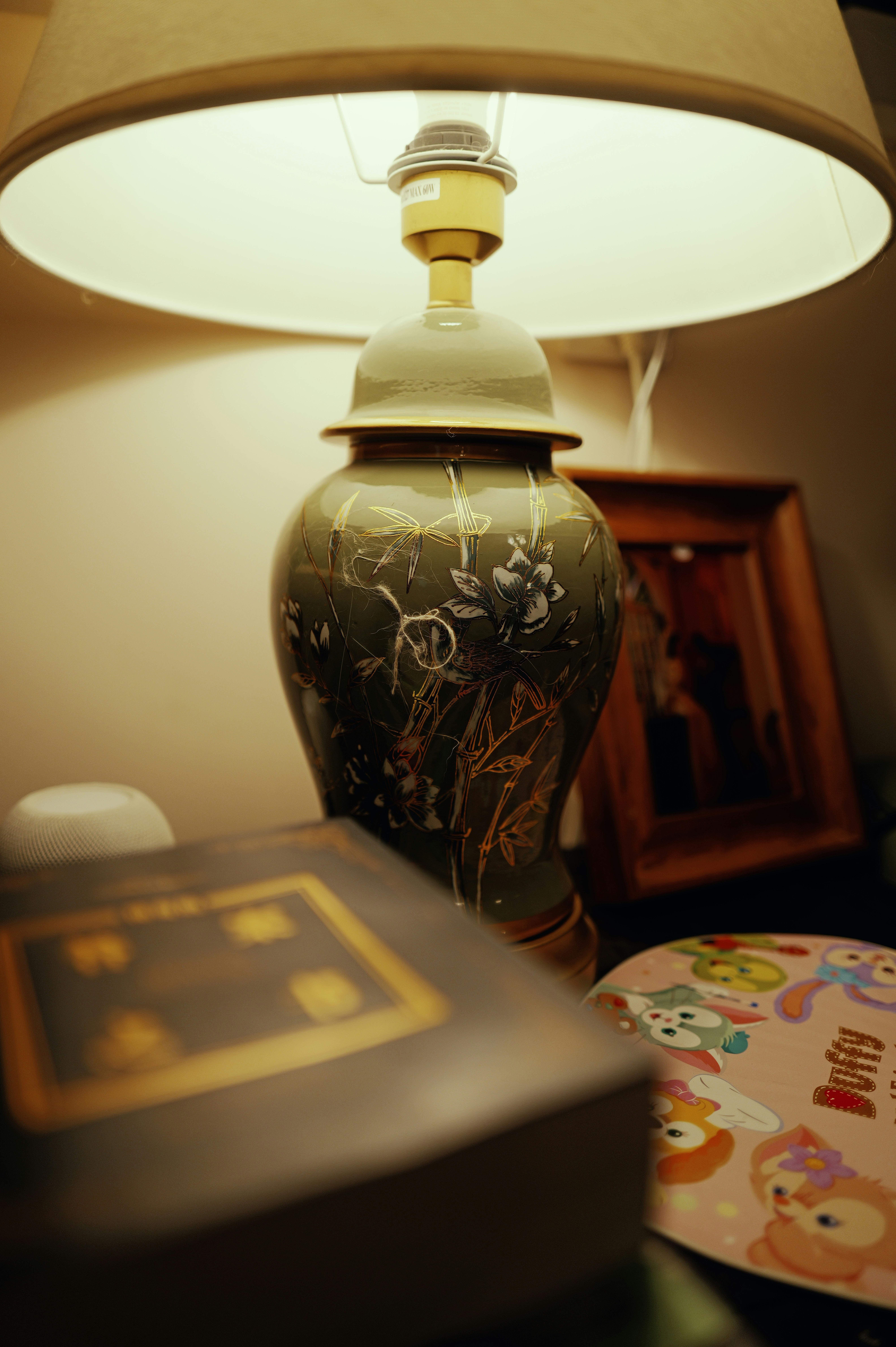 Amber Halo on a Floral Ceramic Vase Beneath a Warm Lamp