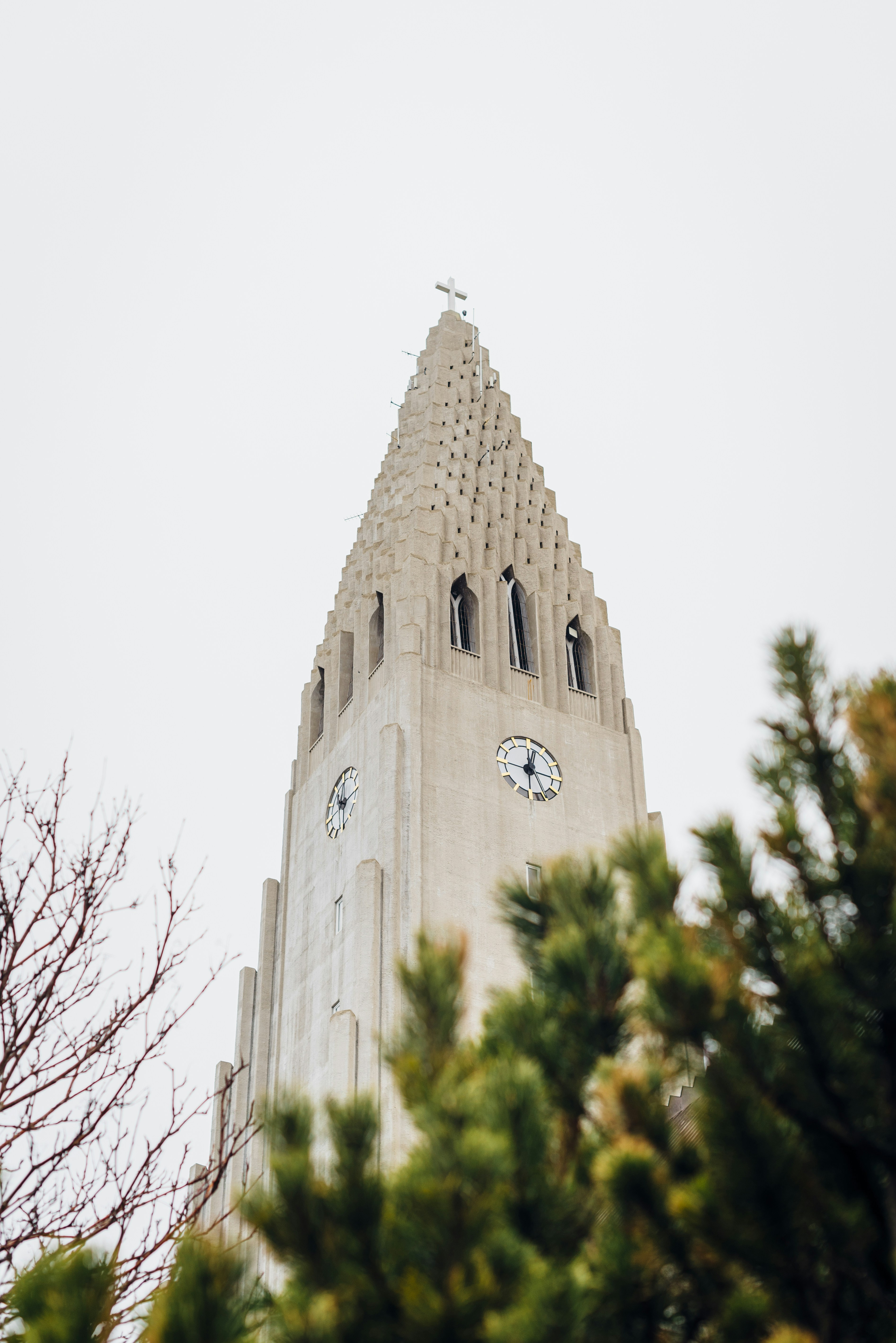 A very tall tower with a clock on it's side photo – Free Iceland Image ...