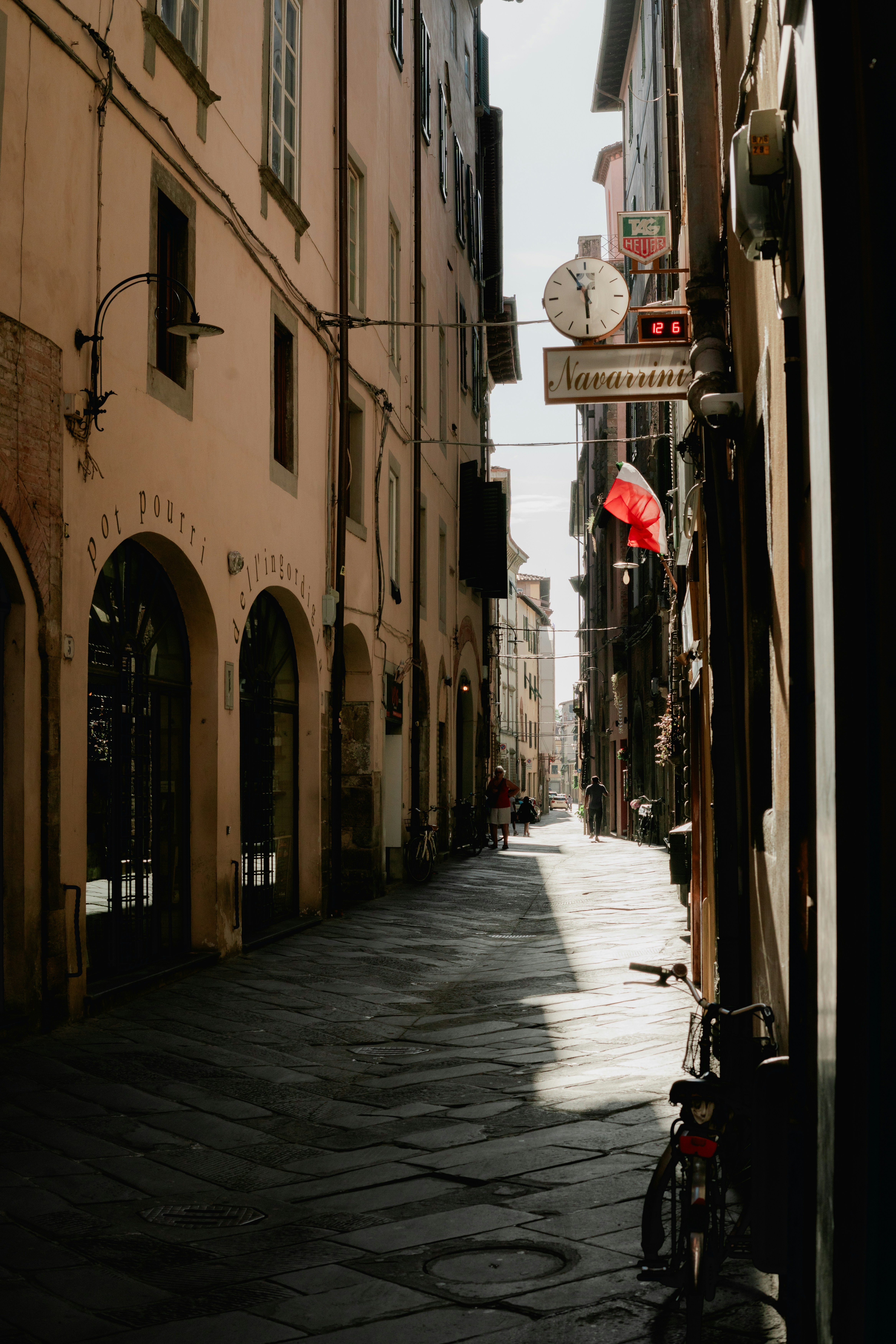 A narrow city street with a red umbrella photo – Free Street ...