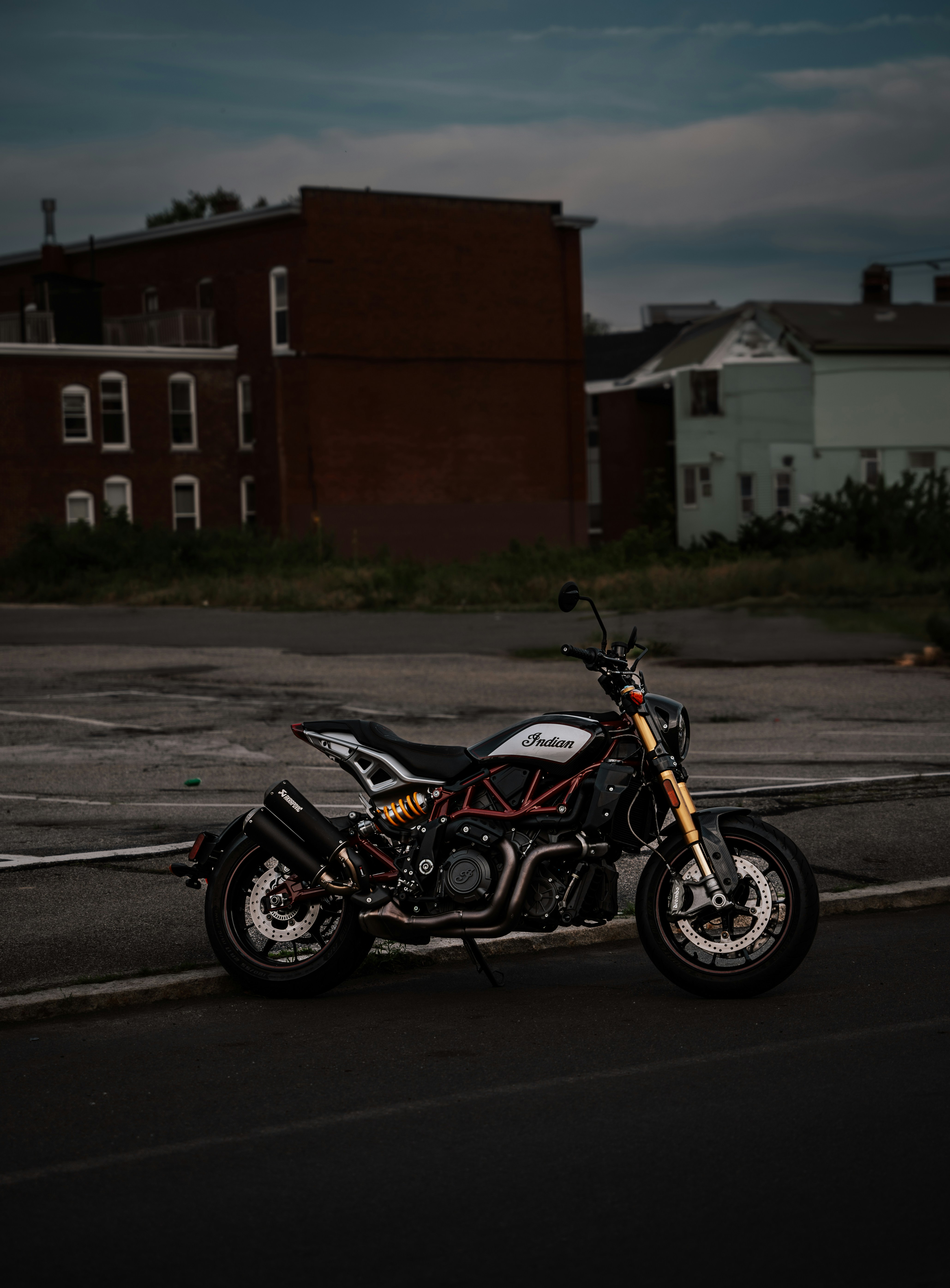 Urban Quiet: Indian Motorcycle Anchored in a Deserted Lot at Dusk