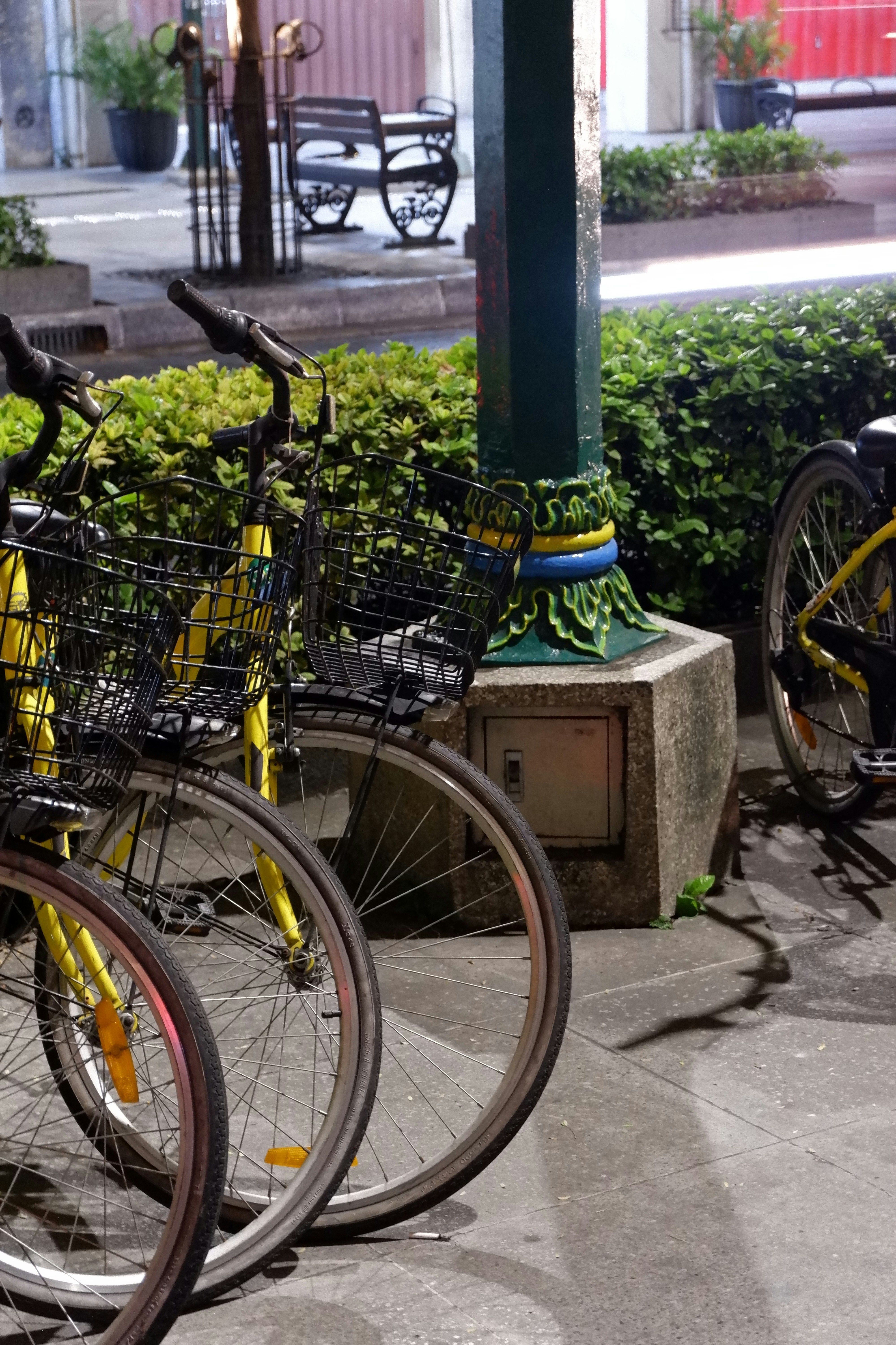 Yellow Bicycles in a Quiet City Nook: Baskets, Shadows, and Steel