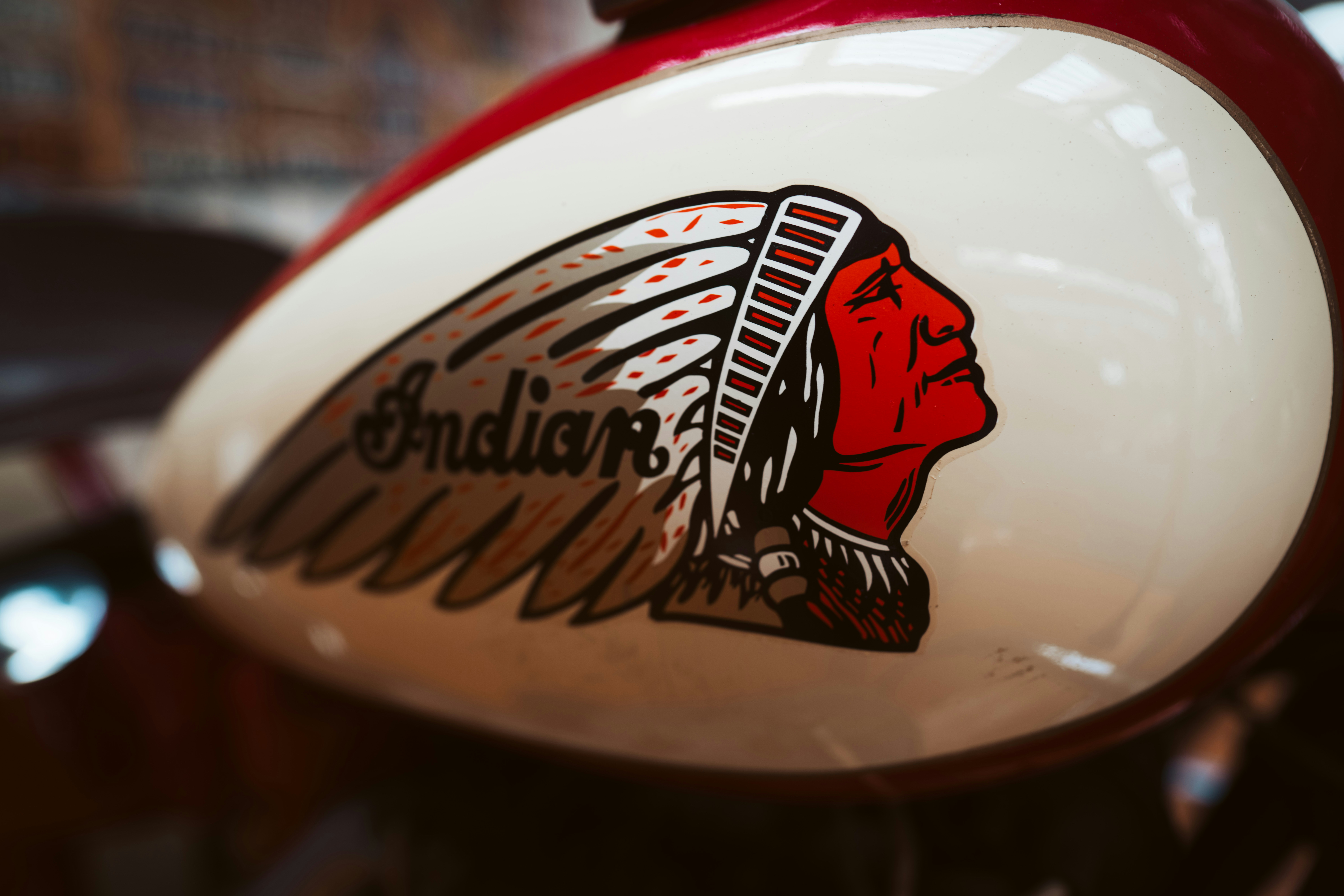 Red Portrait on Painted Shell: Native Chief Emblem on a Motorcycle Tank