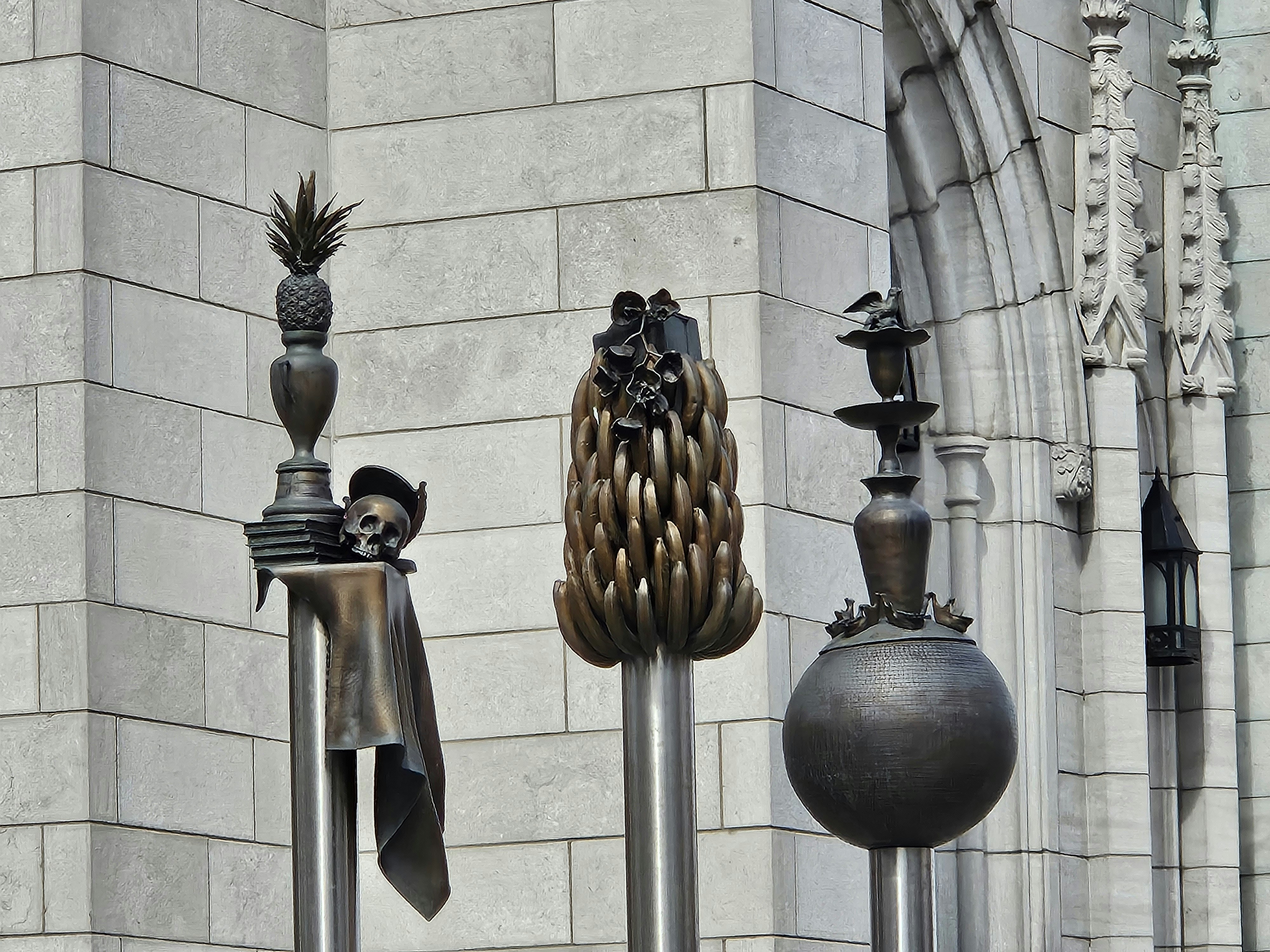 Bronze Trio Guarding the Stone Facade